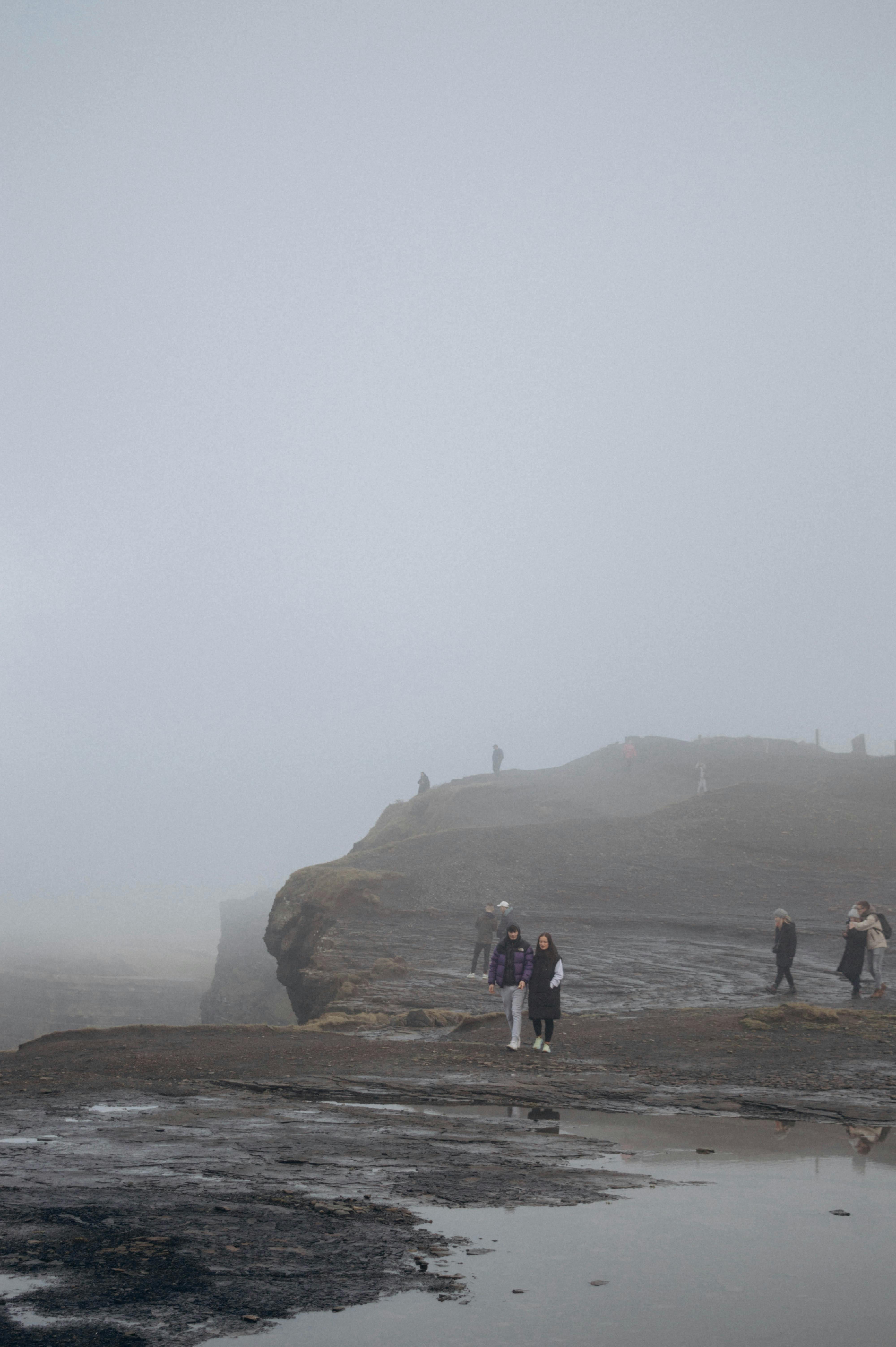 Photo of People Walking on a Cliff in Fog · Free Stock Photo