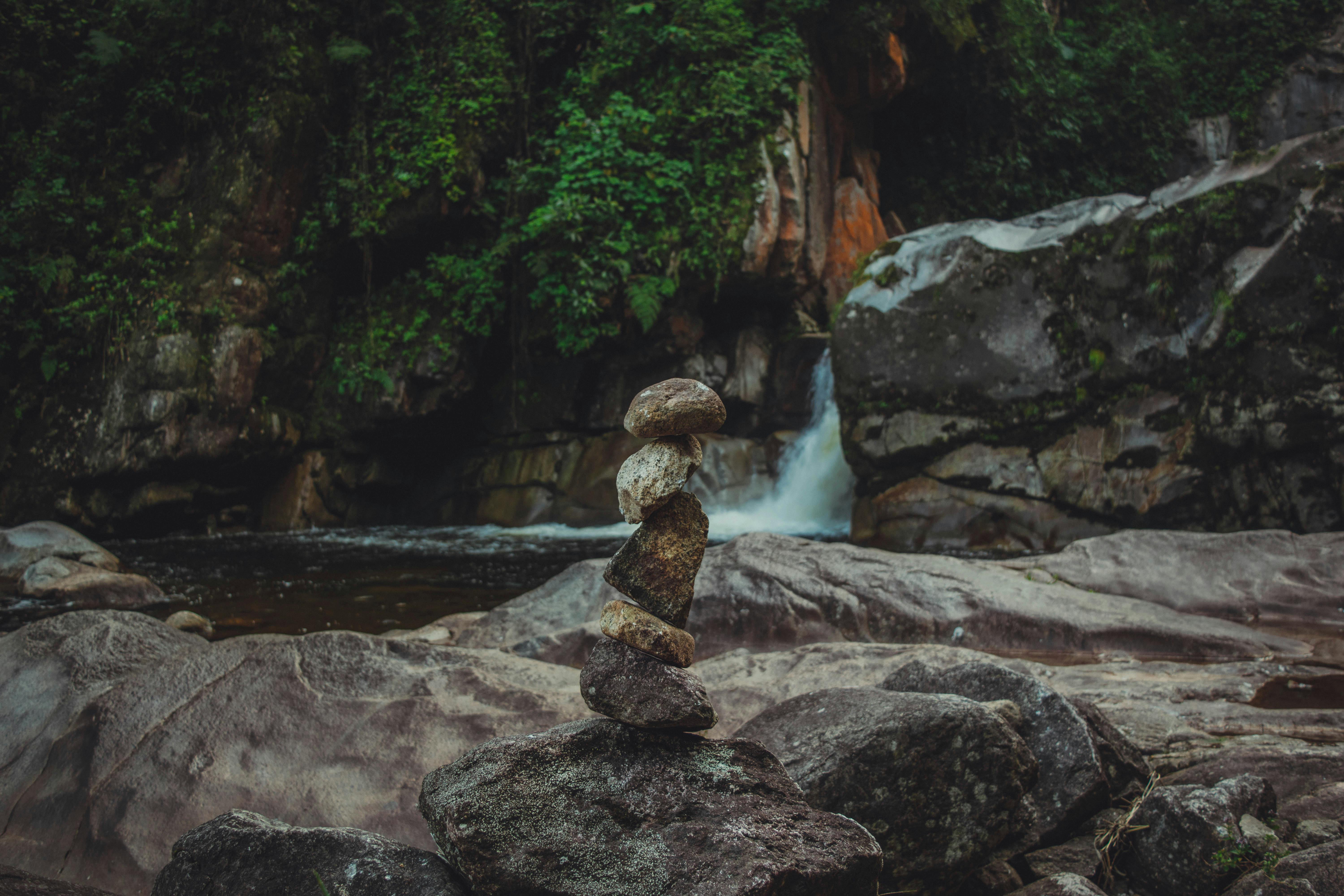 Close-up of a Stack of Stones on the Background of a Waterfall · Free ...