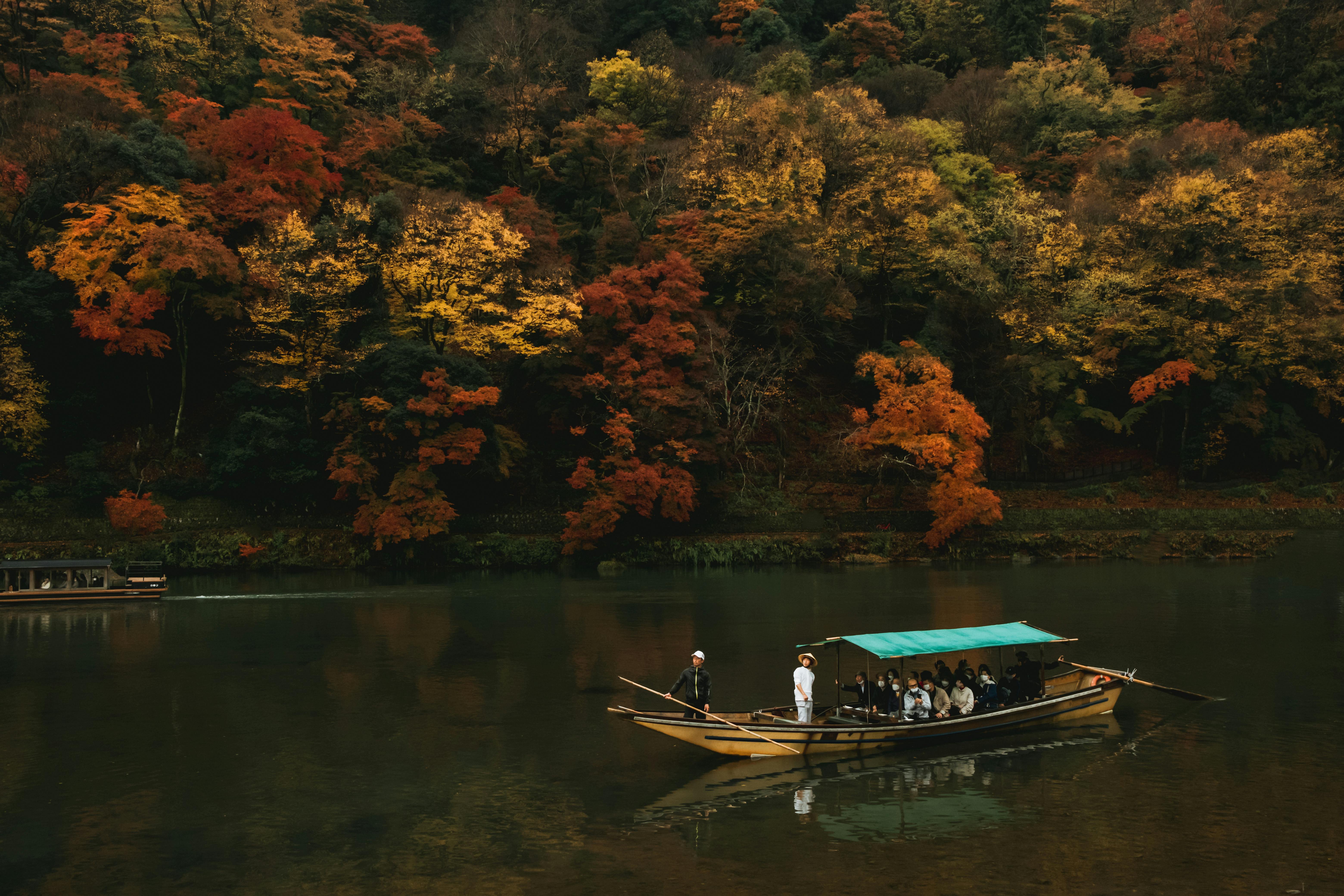 Passengers Travelling by Boat along River in Autumn · Free Stock Photo