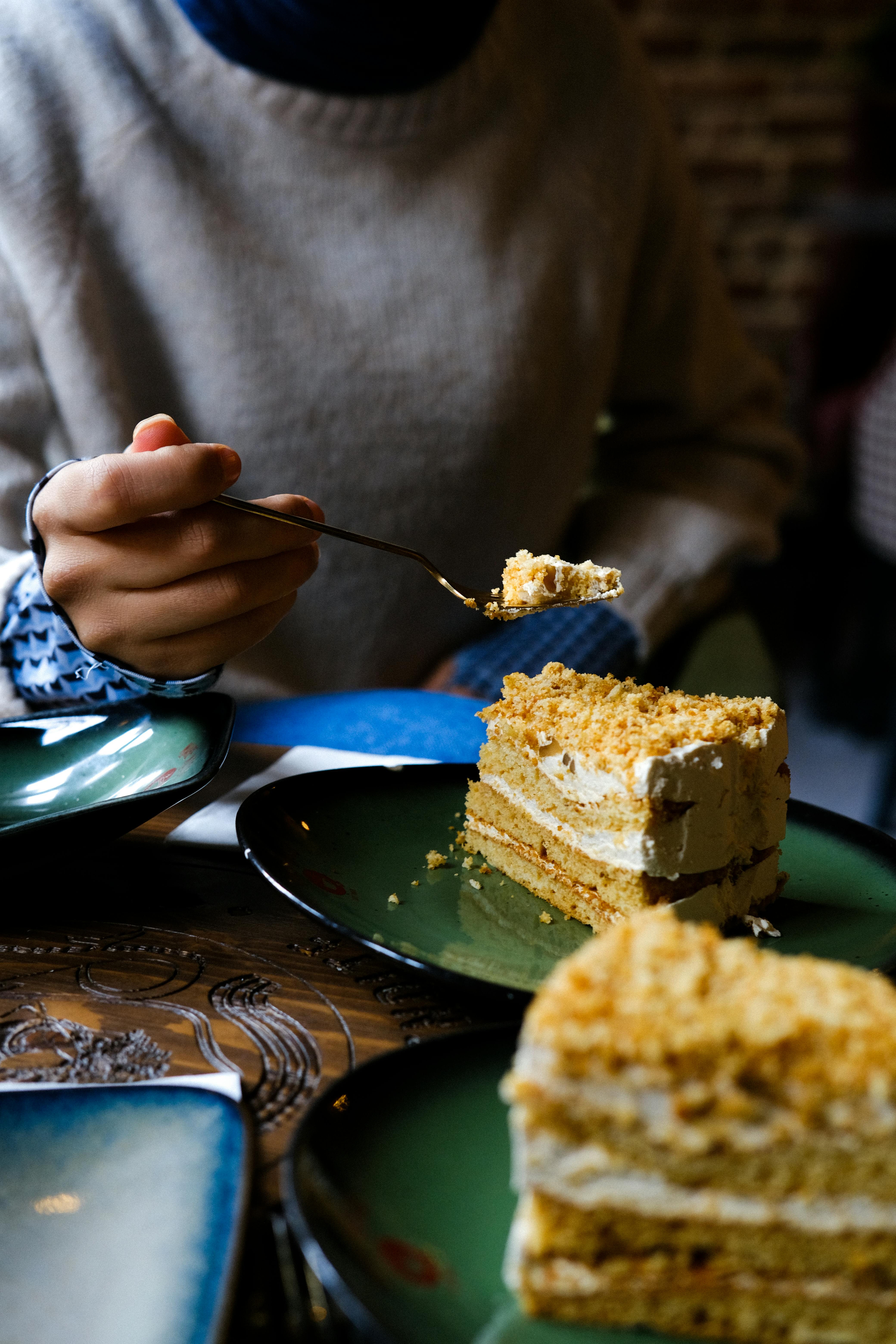 Hand with Fork over Cakes · Free Stock Photo