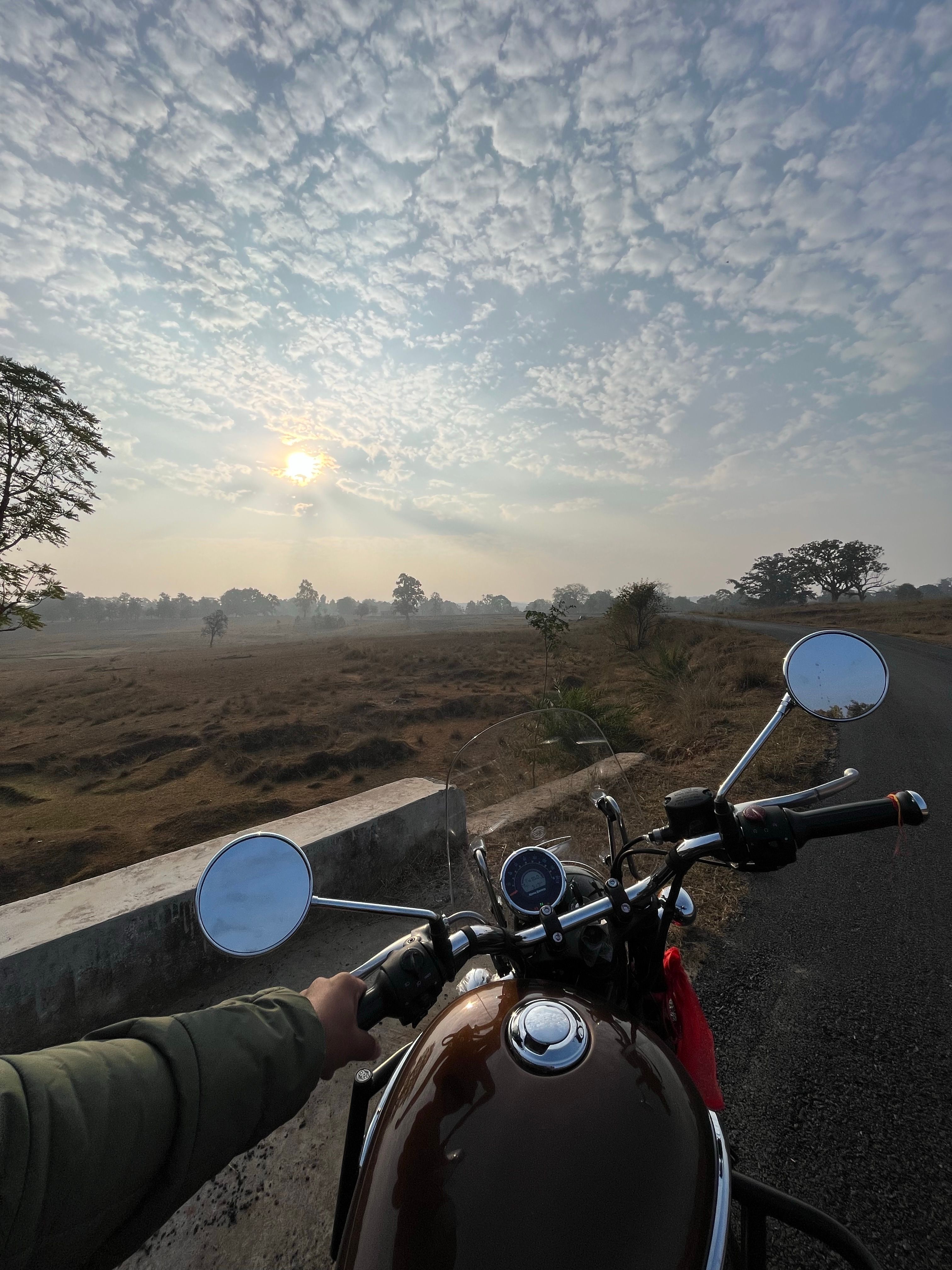 Sun and Clouds over Motorcycle · Free Stock Photo