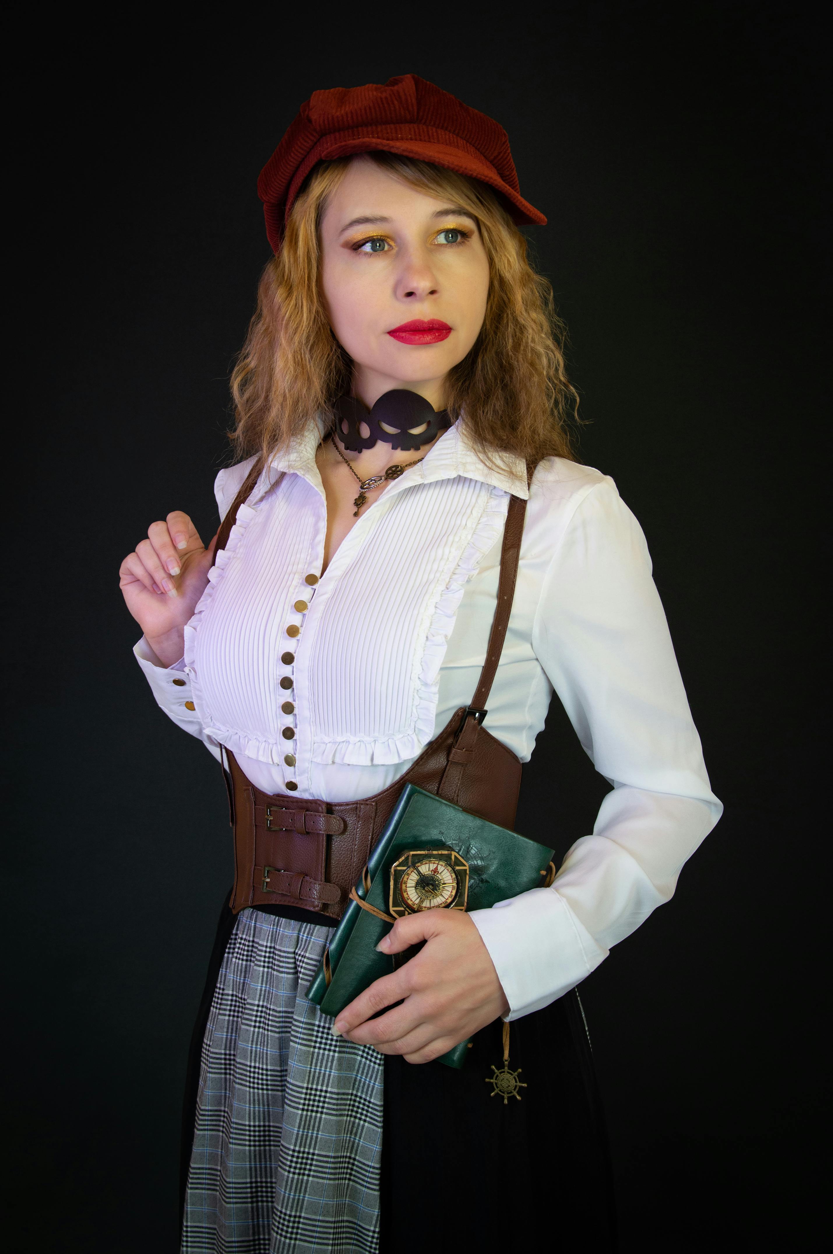 A Blonde Woman in Red Costume Holding a Gun · Free Stock Photo