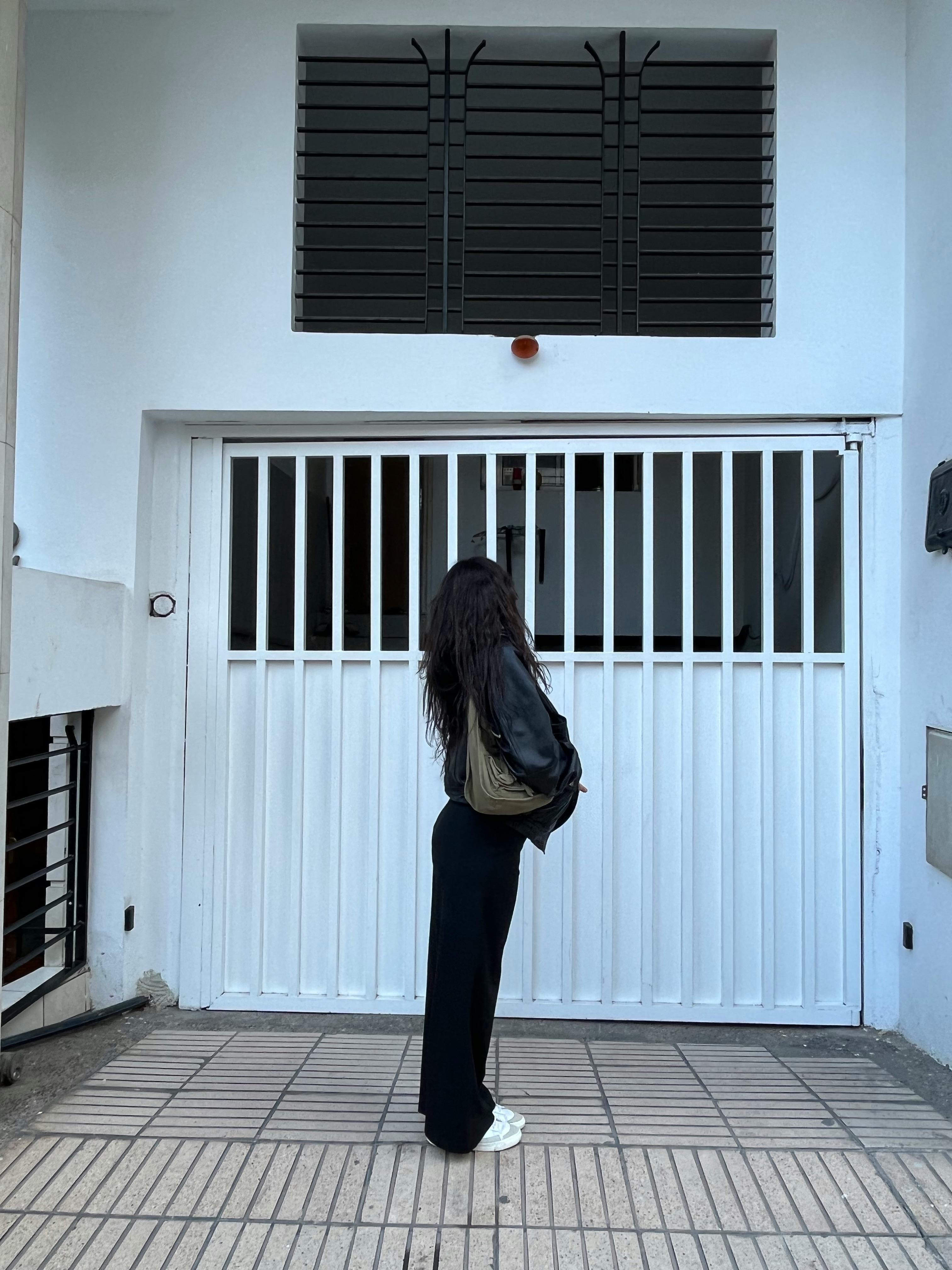 Woman Standing near White Gate and Wall · Free Stock Photo
