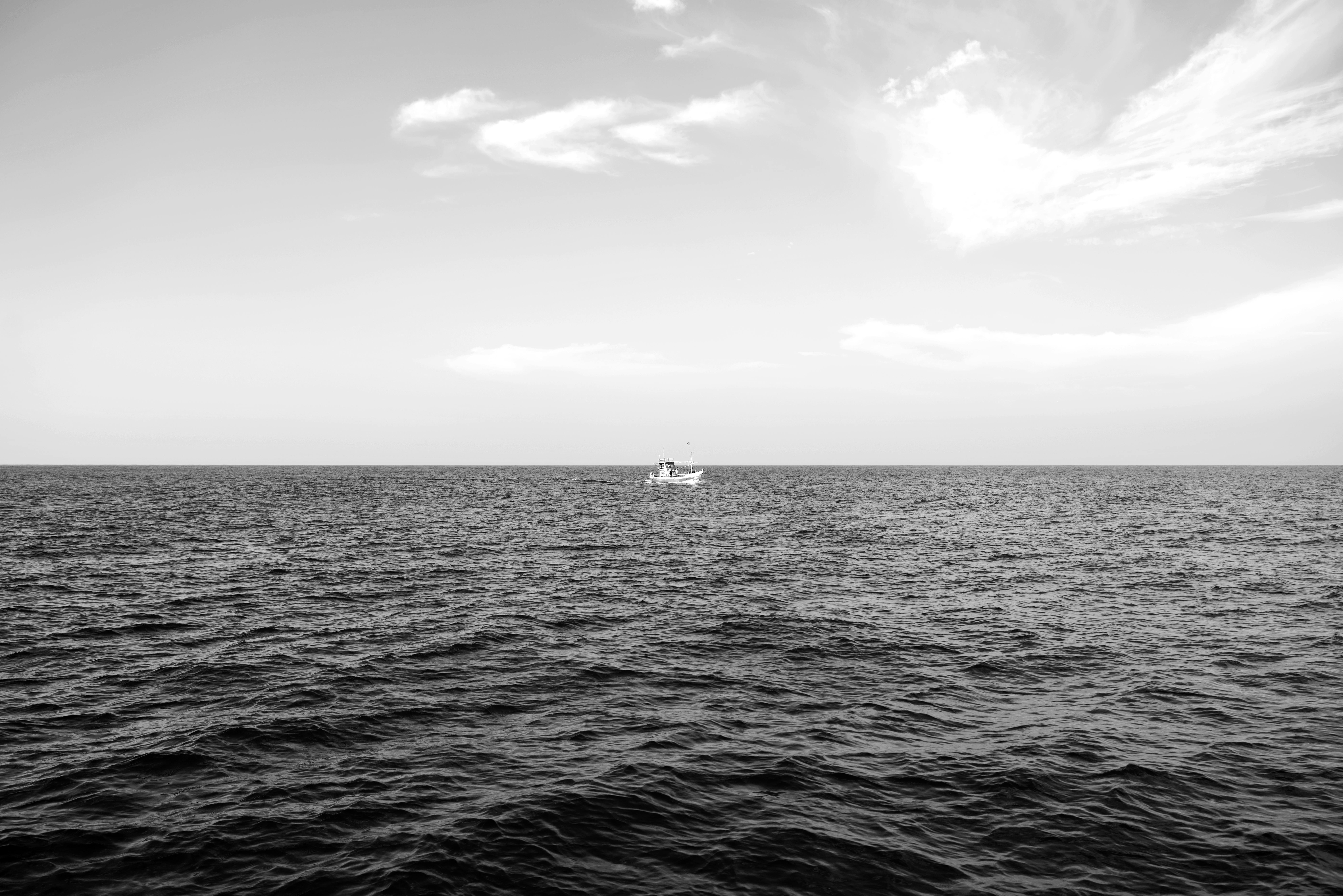 Grayscale Photography of a Ship Sailing on the Sea · Free Stock Photo