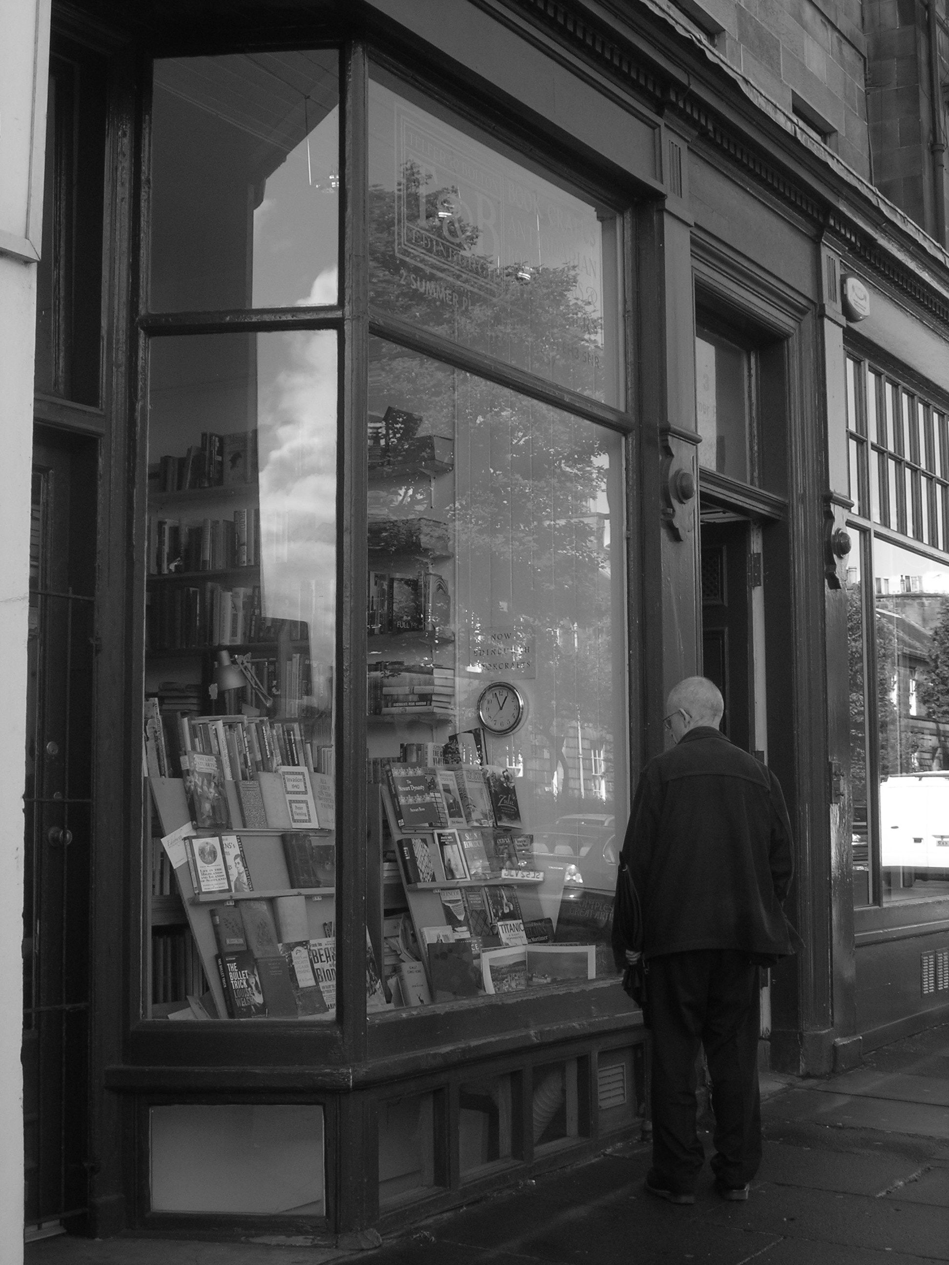 Man Looking Through the Window at the Books on the Display of a ...