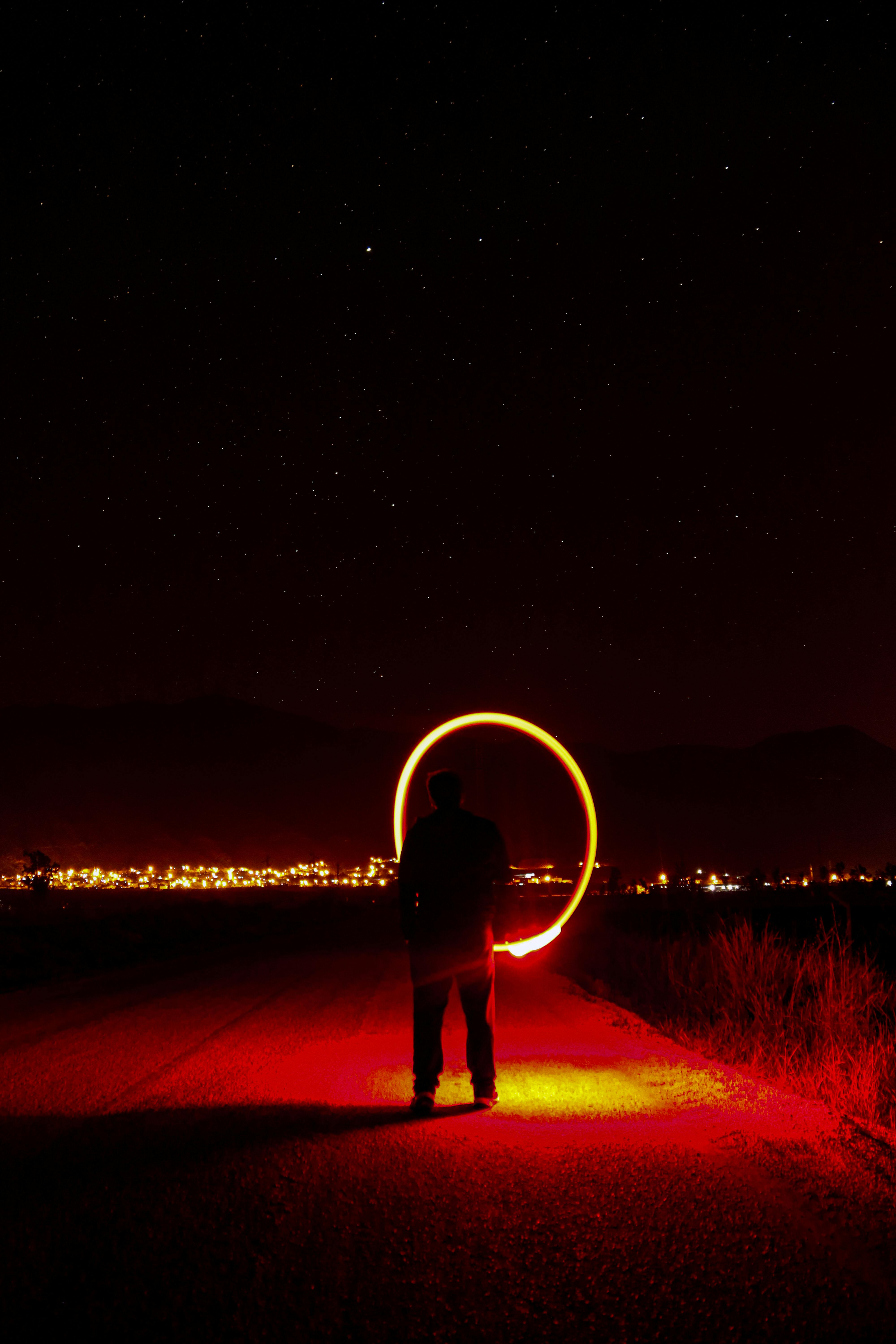 Man Standing With Round Light at Night · Free Stock Photo