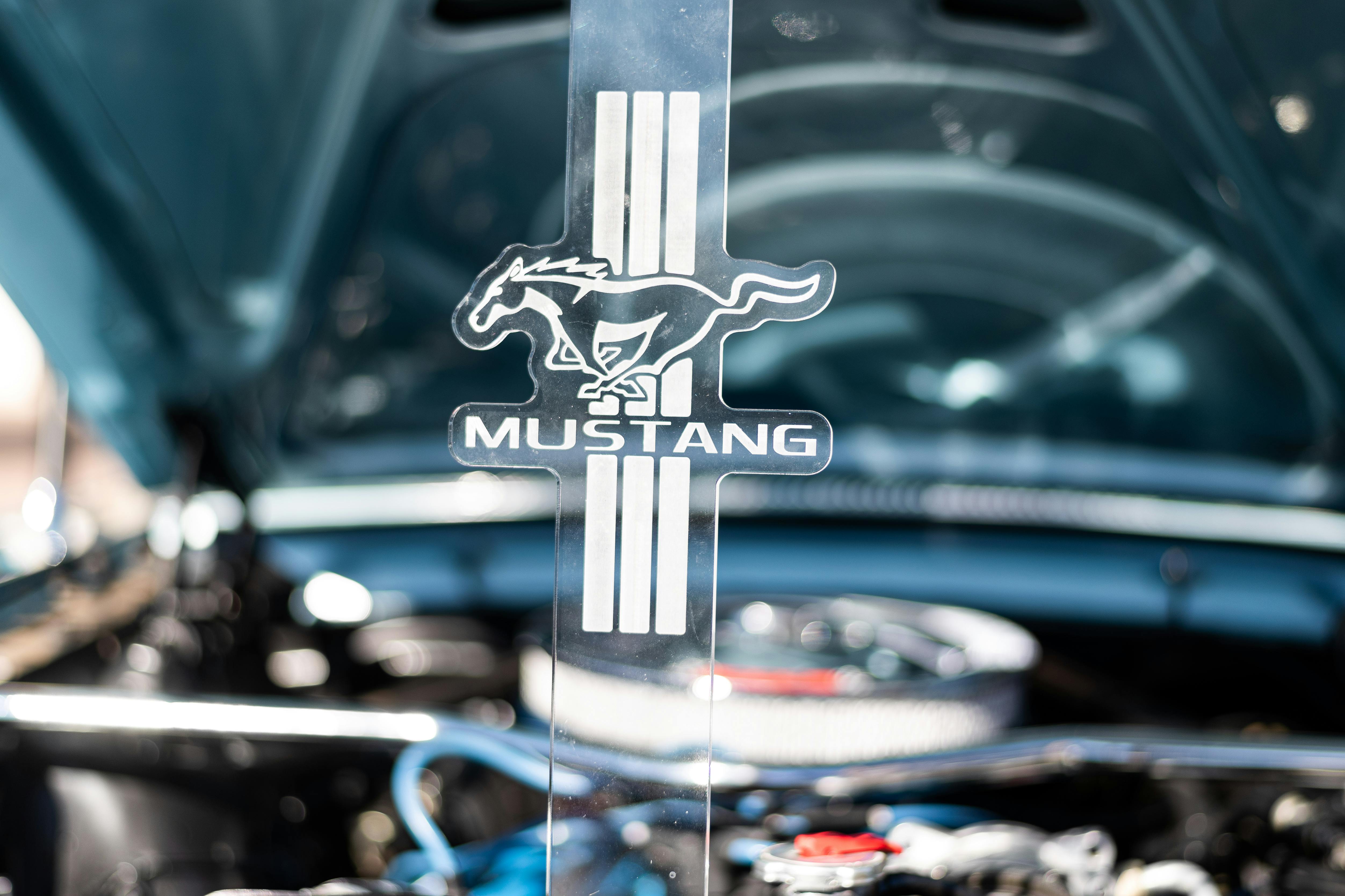 Close-up of Ford Mustang Sign on the Background of an Opened Car Hood ...