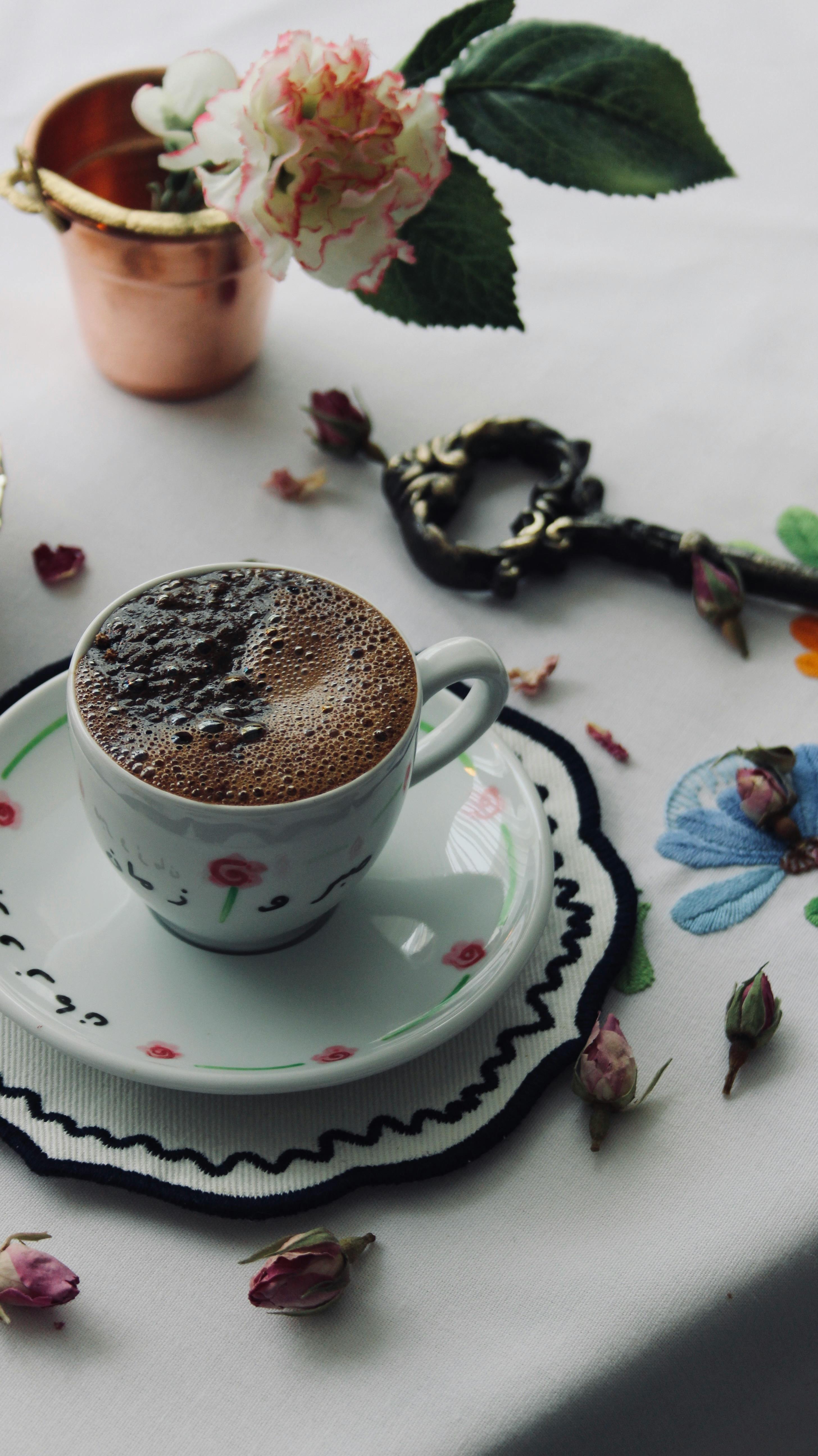 Cup of Black Coffee, Key and Flowers on Table · Free Stock Photo