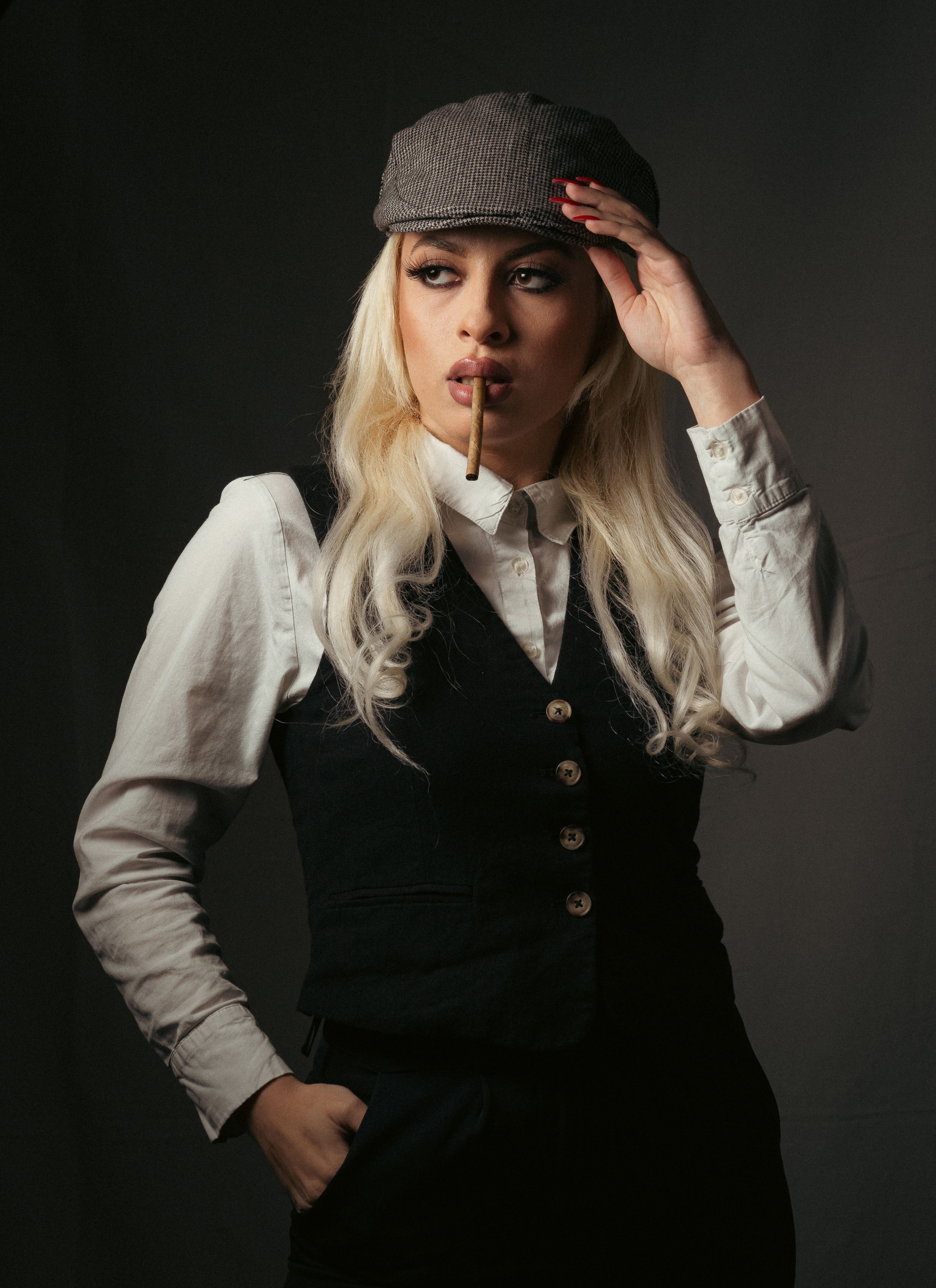 Young Woman in a Suit, Cap and Smoking a Cigarillo · Free Stock Photo