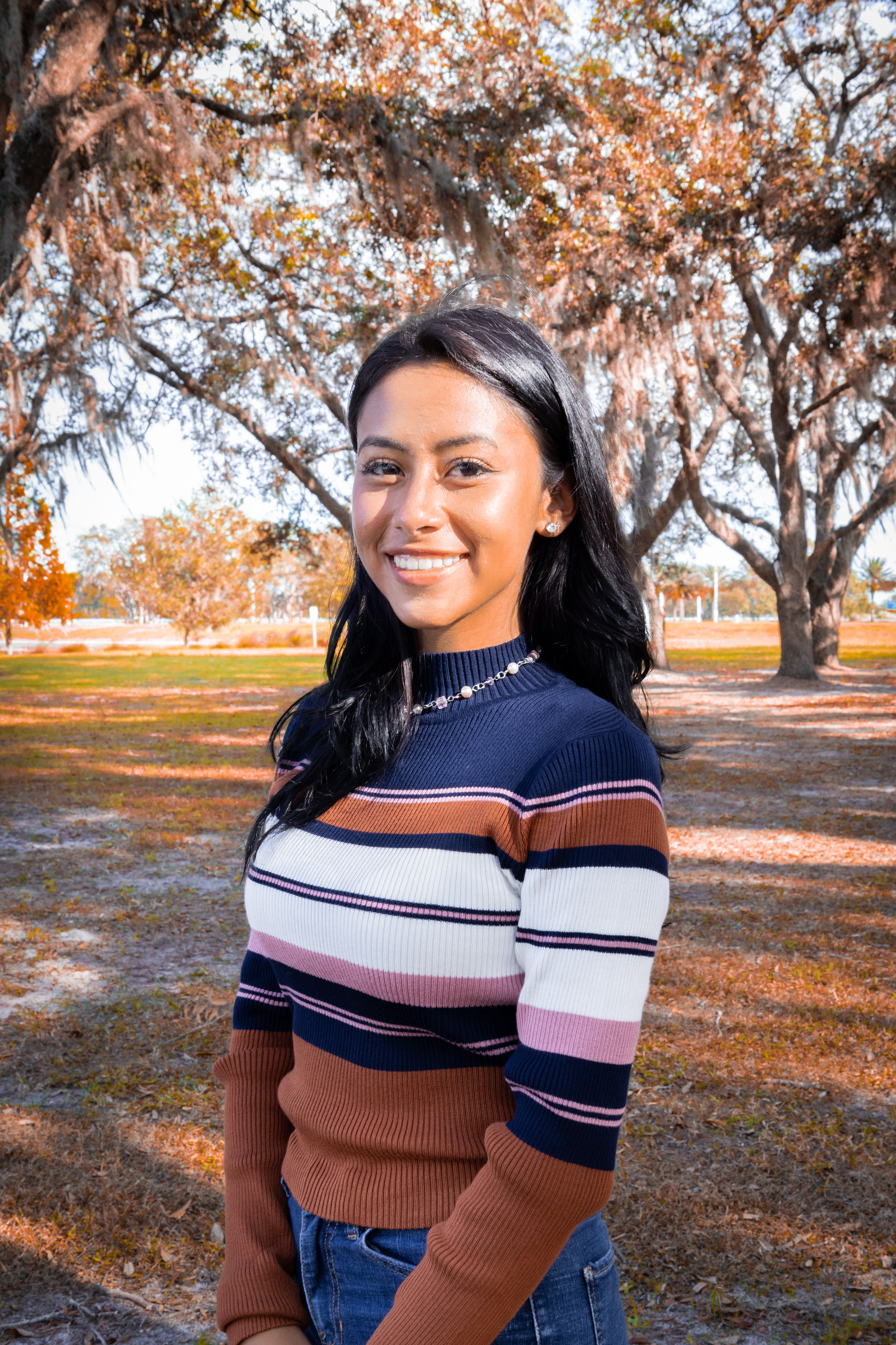 Portrait of a Woman Smiling in a Park · Free Stock Photo