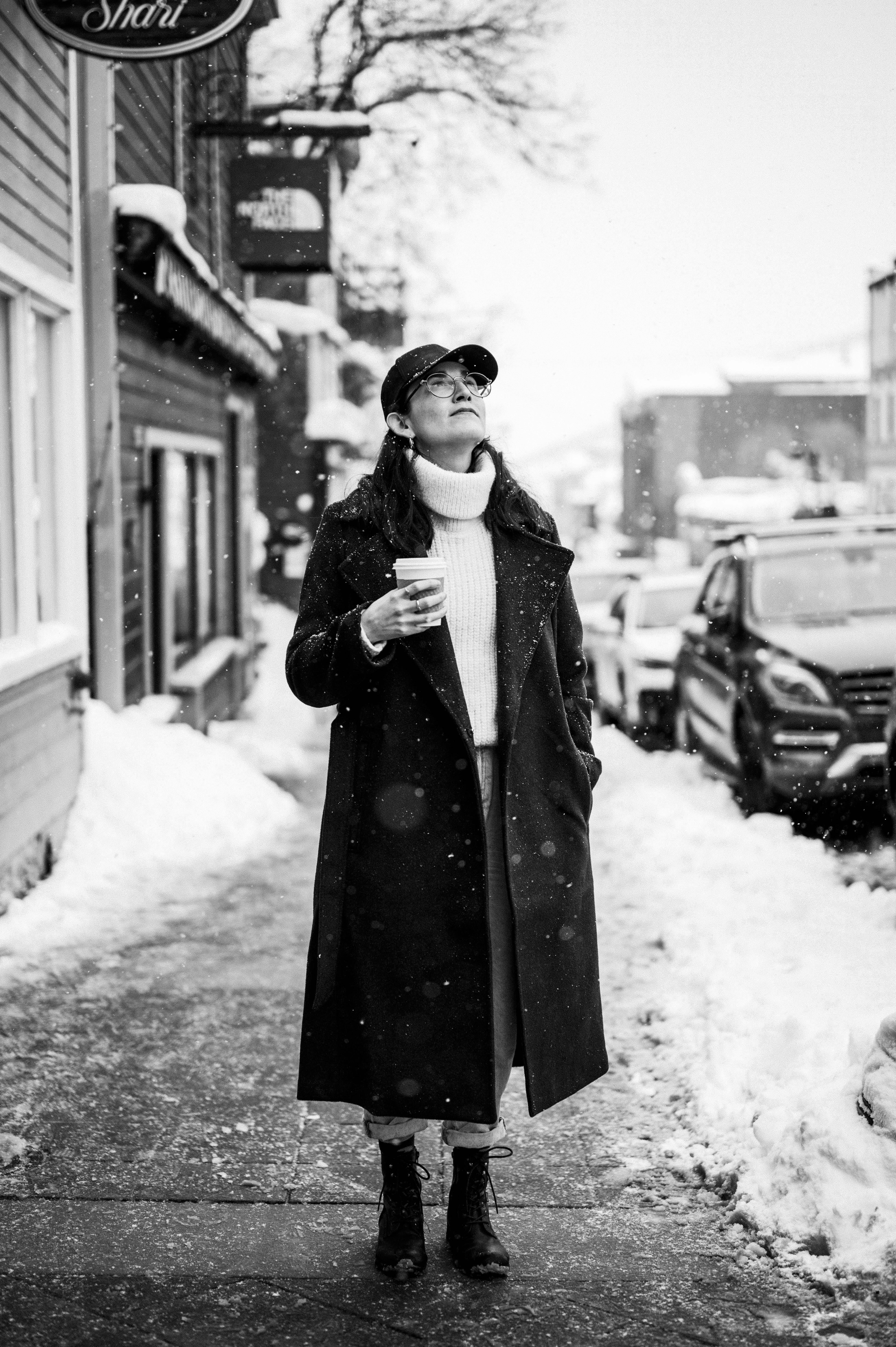 Passerby with a Cup of Coffee Looking at the Falling Snow · Free Stock ...