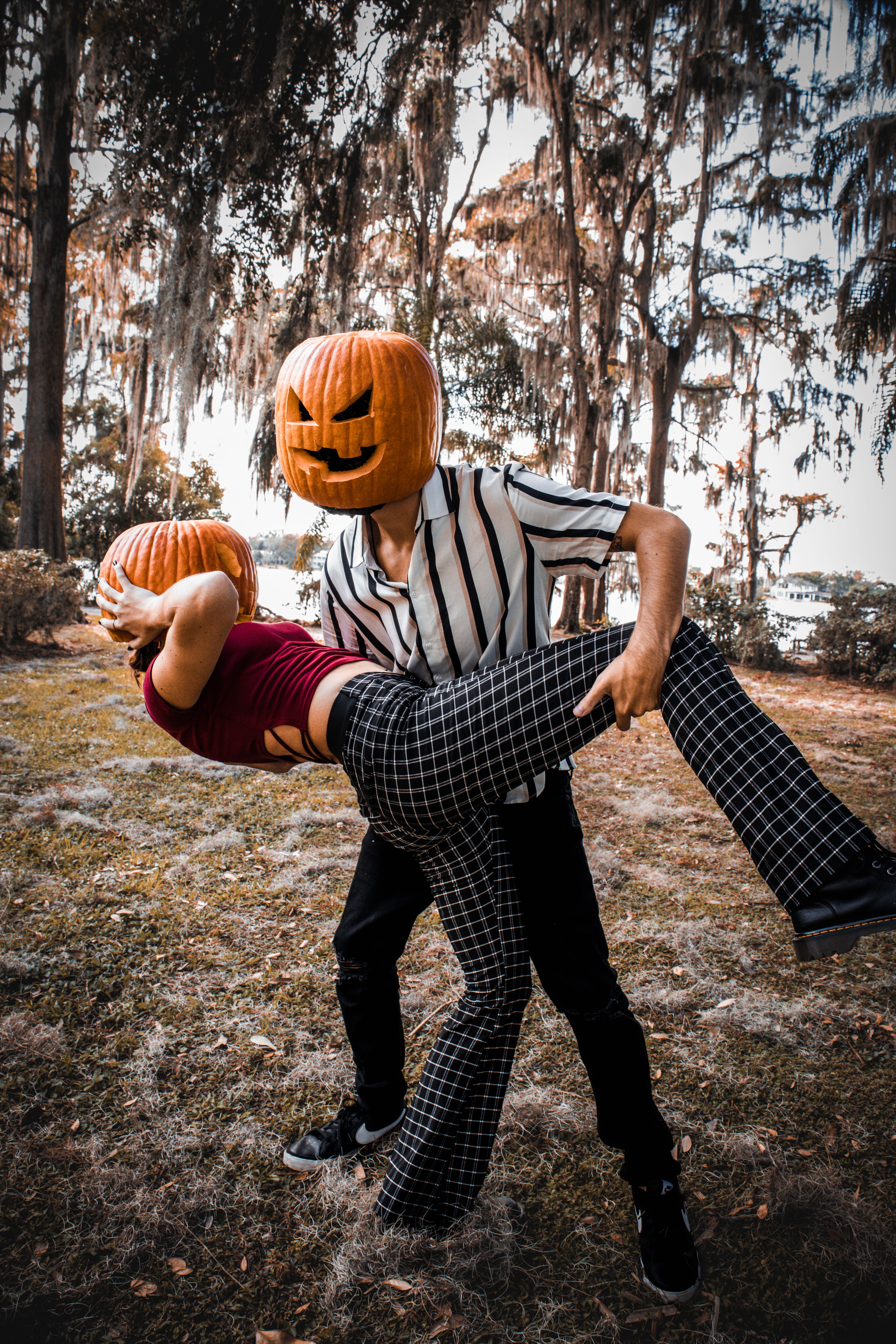 Couple in Jack-o-lantern Masks Dancing in the Park · Free Stock Photo
