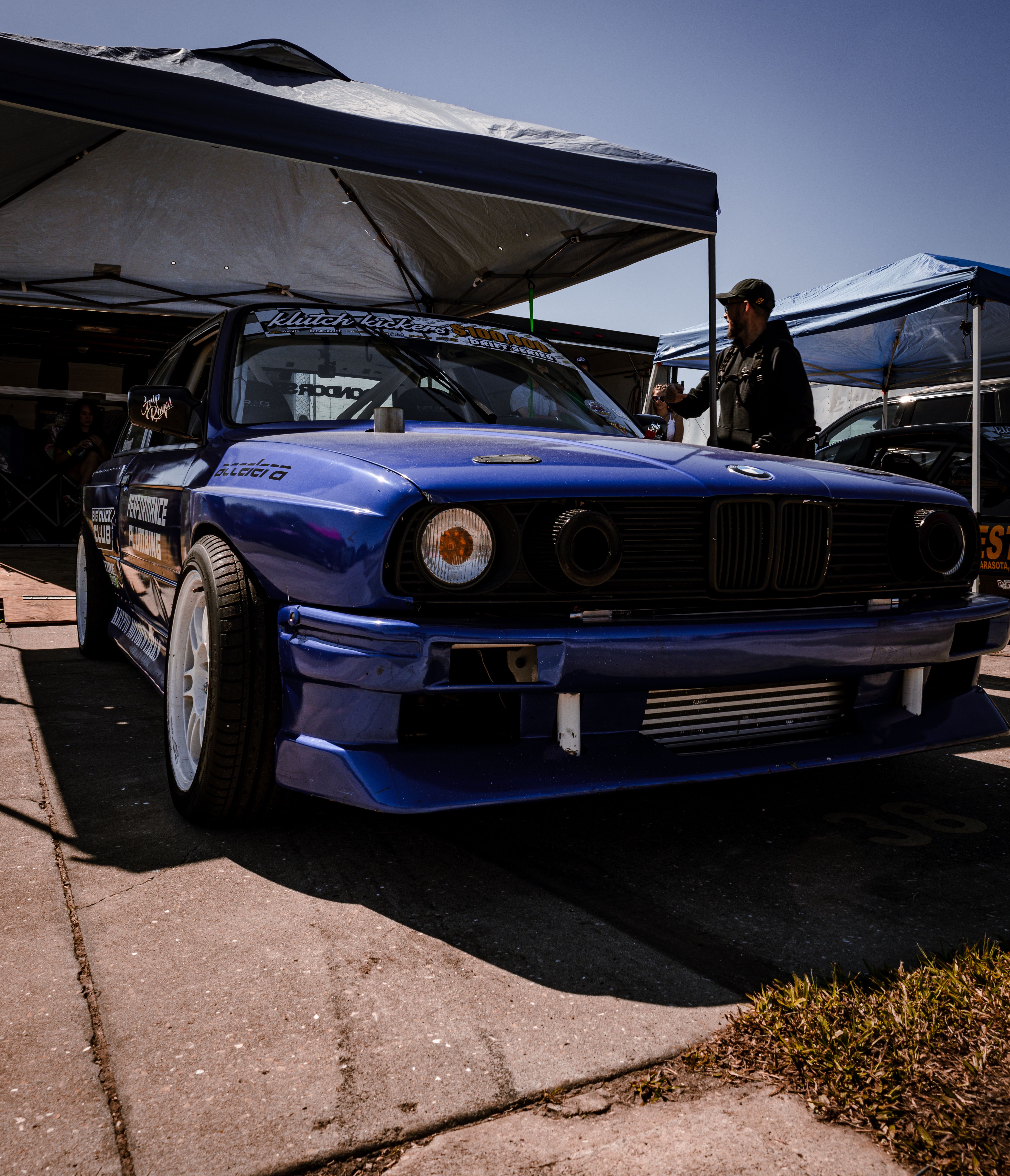 Racing Navy Blue BMW M3 E30 Under a Tent · Free Stock Photo