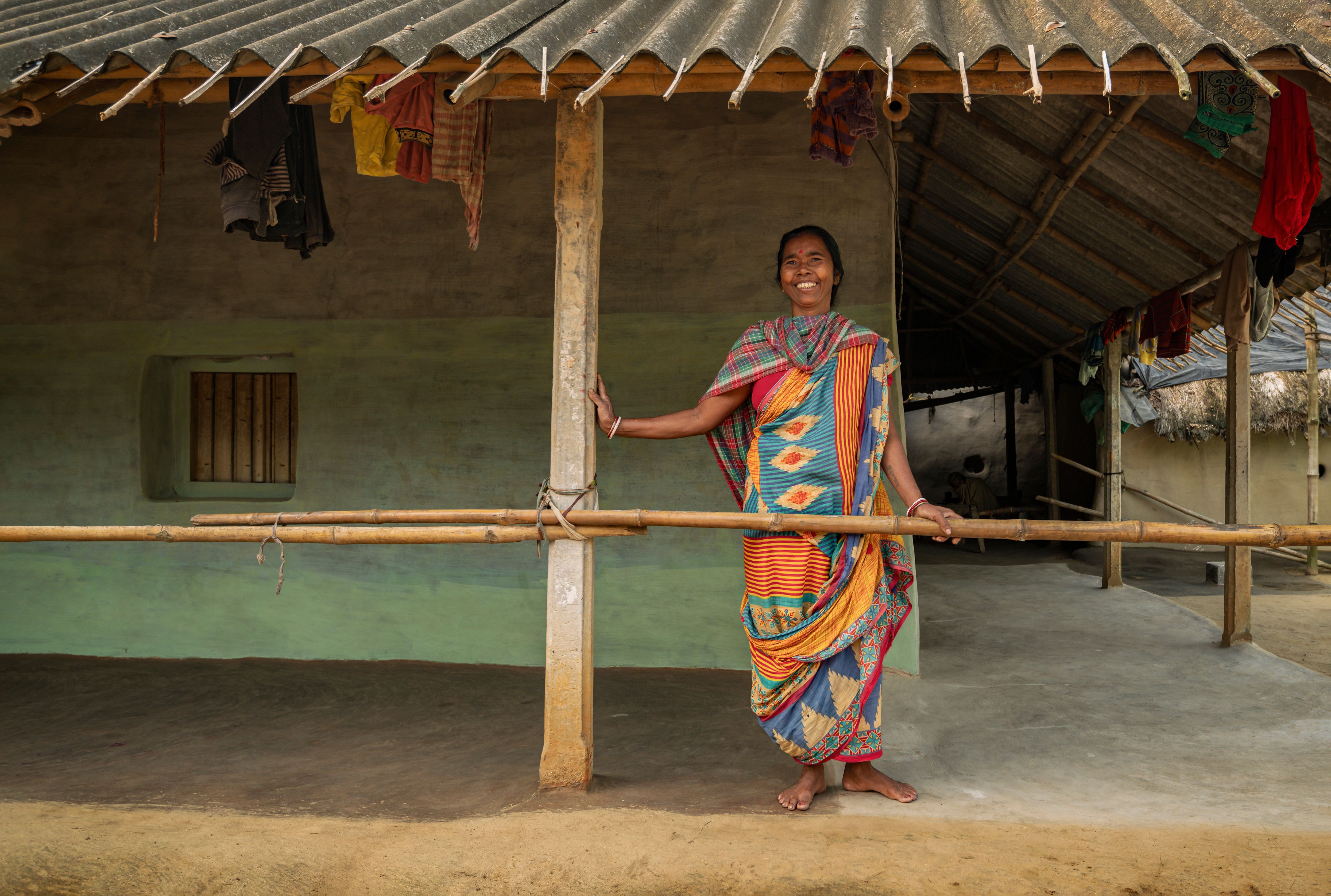 Smiling Woman in Traditional Clothing by House in Village · Free Stock ...