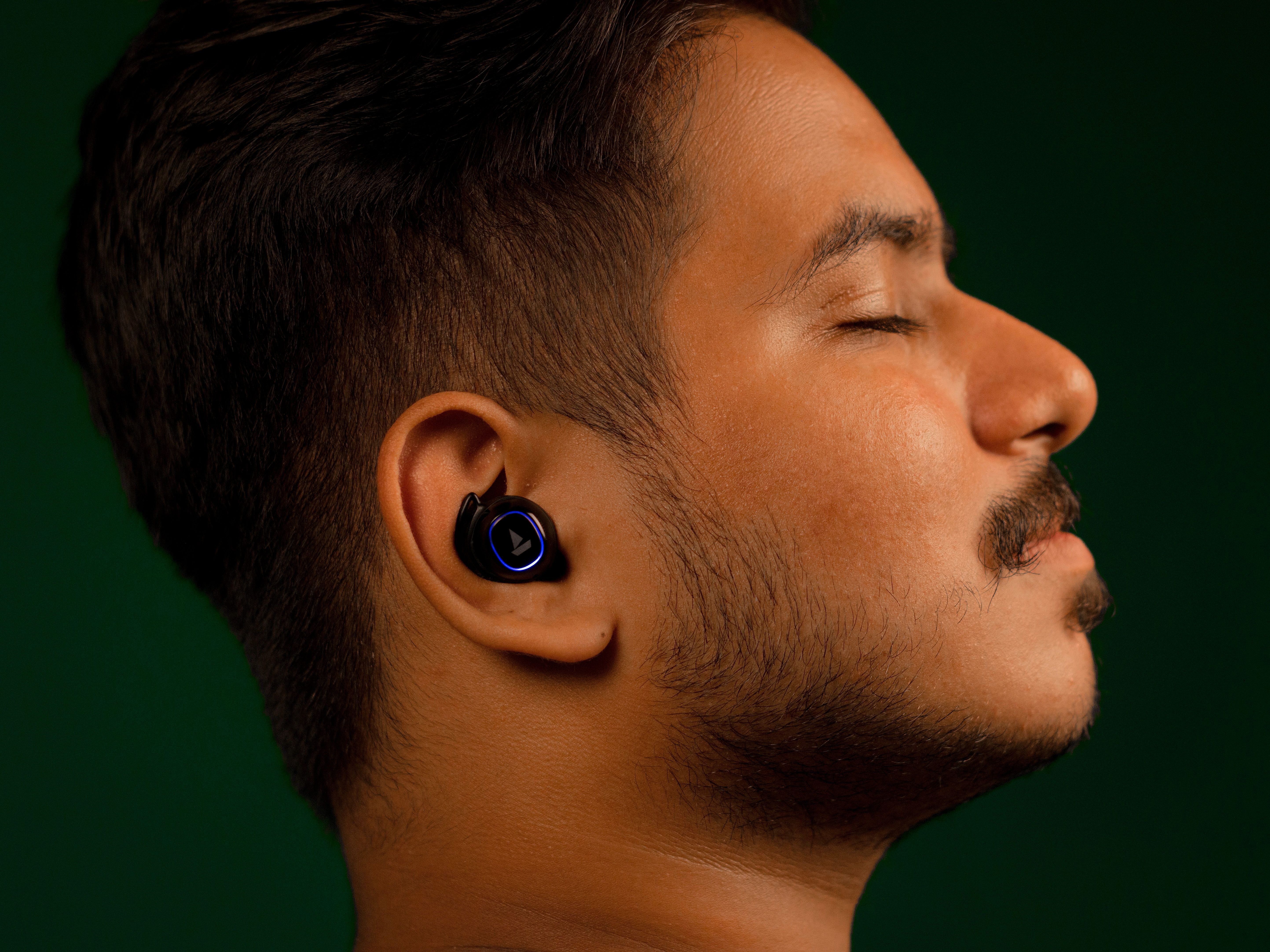 A Man Wearing Blue and Black Earbud · Free Stock Photo