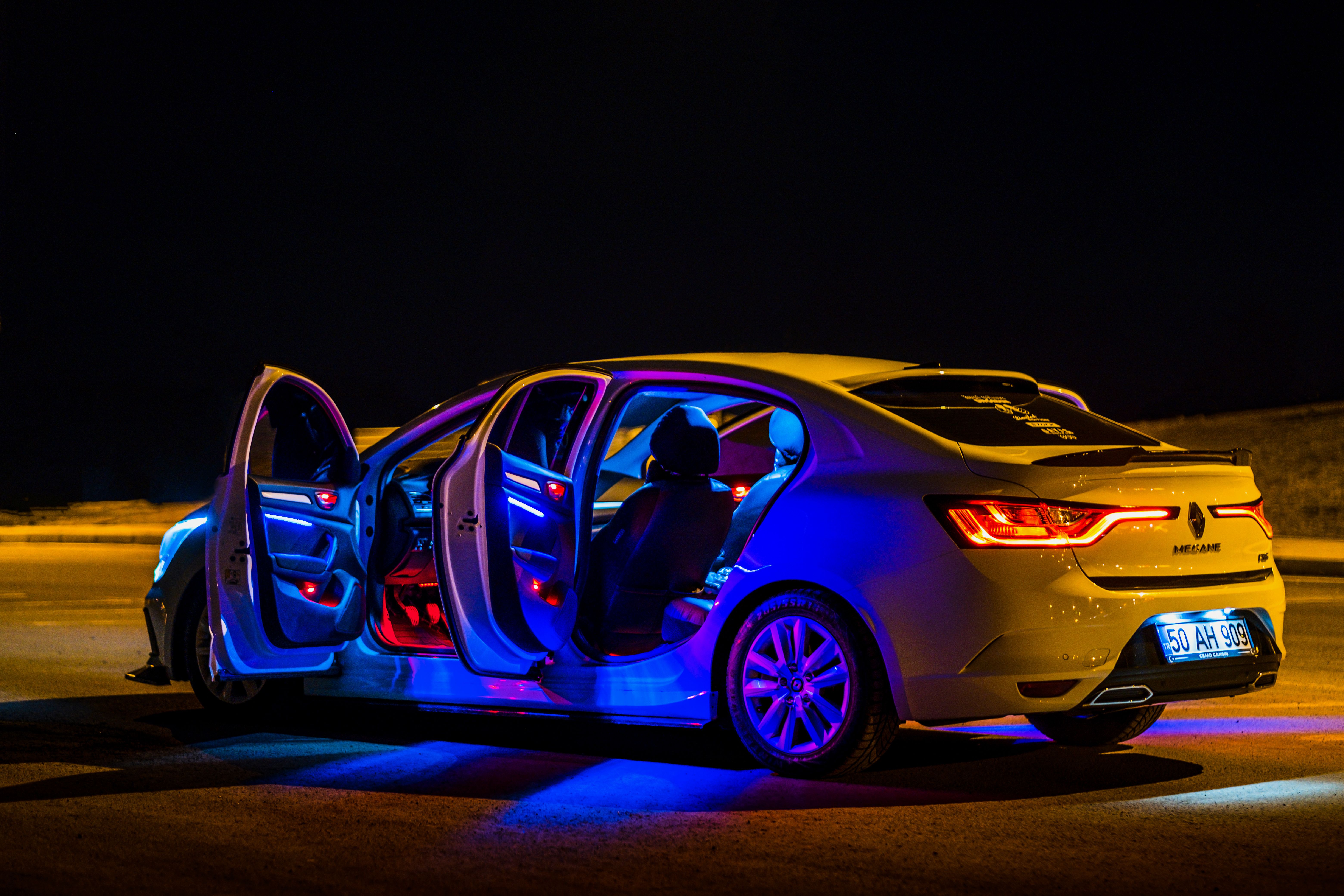 Sleek Sports Car Outside Urban Building at Night · Free Stock Photo