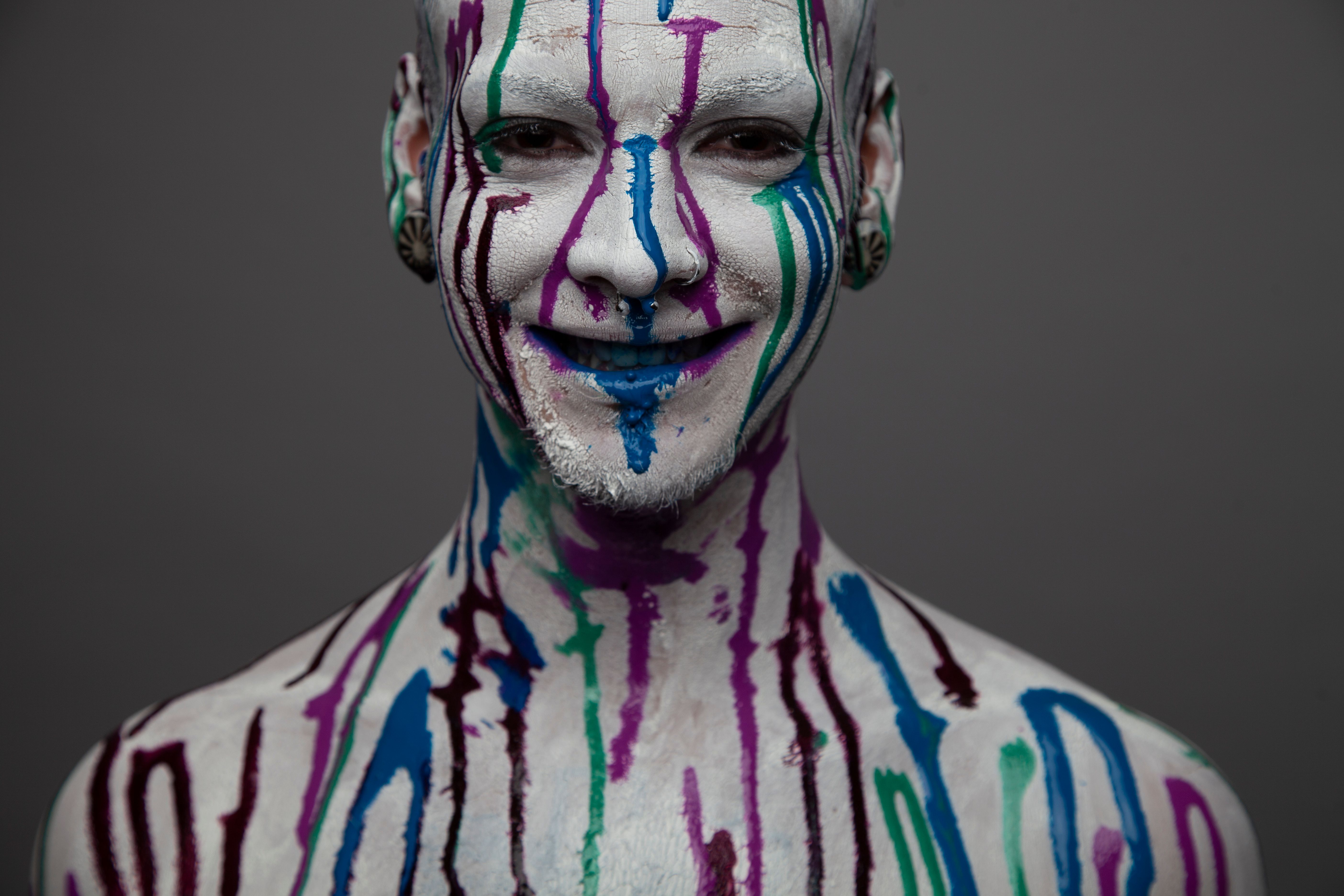 Smiling Man with Colorful Paint on Face · Free Stock Photo