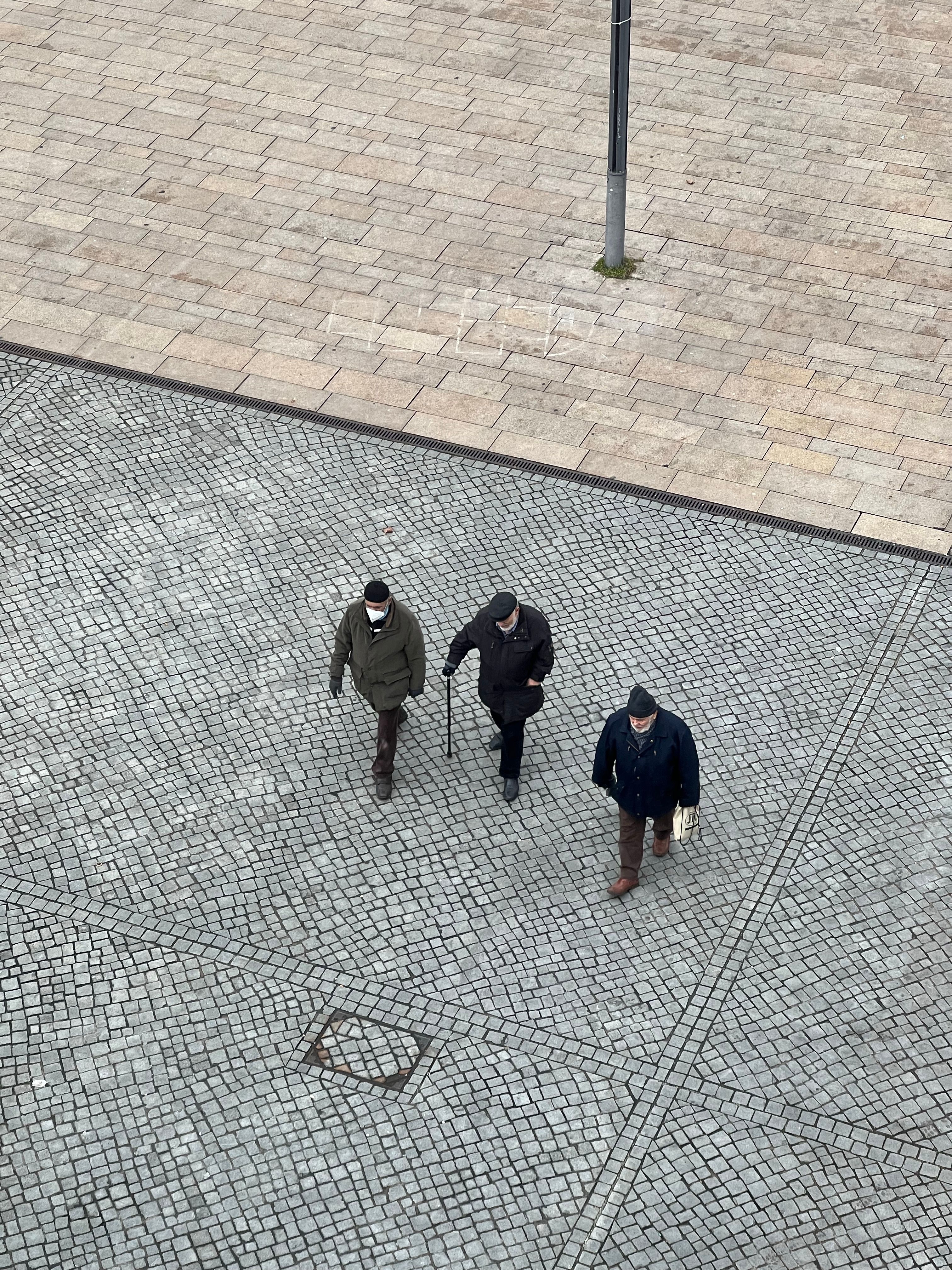Elderly Men Walking on the Cobblestone Square · Free Stock Photo