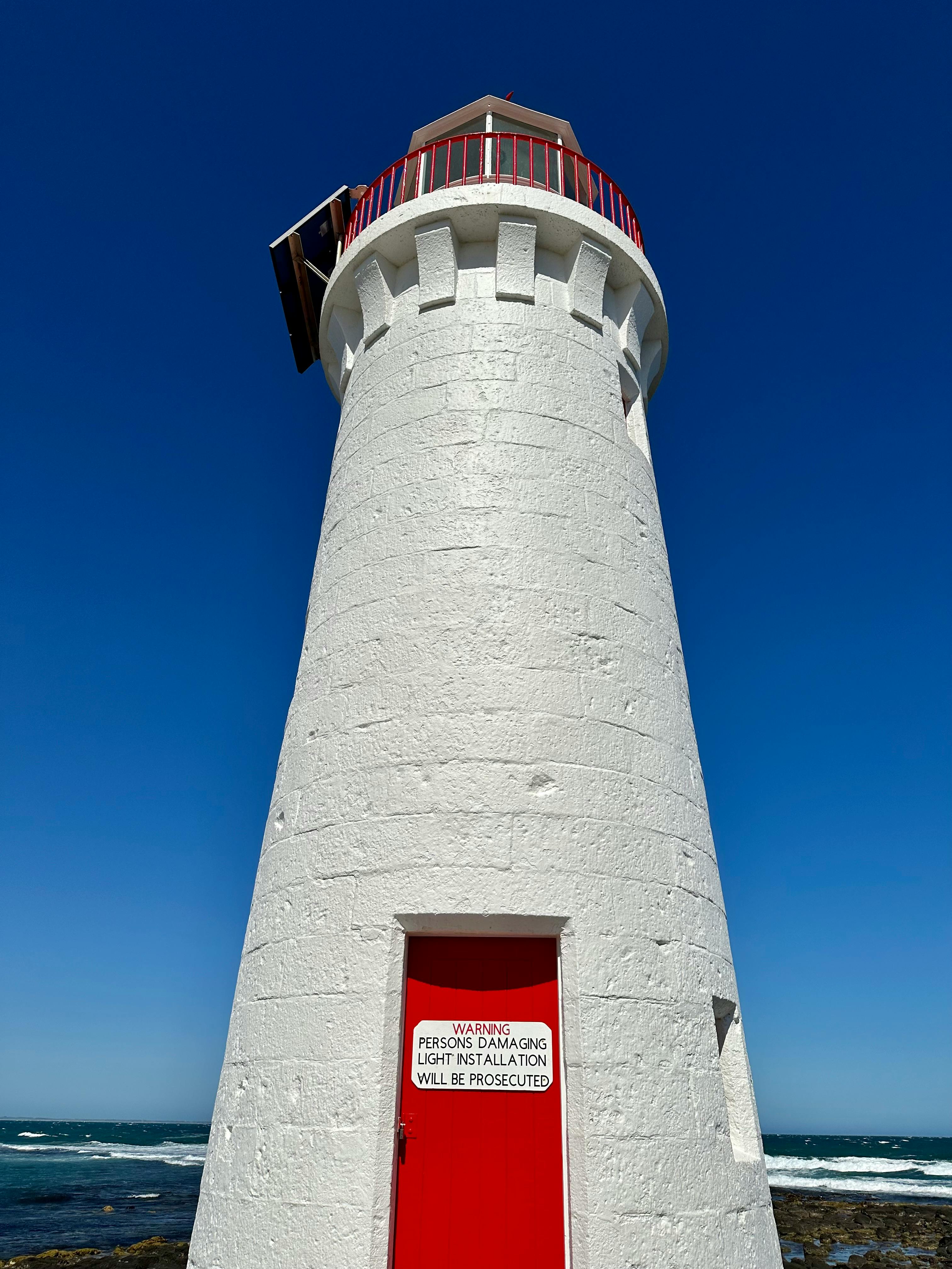 Sunlit Lighthouse Wall · Free Stock Photo