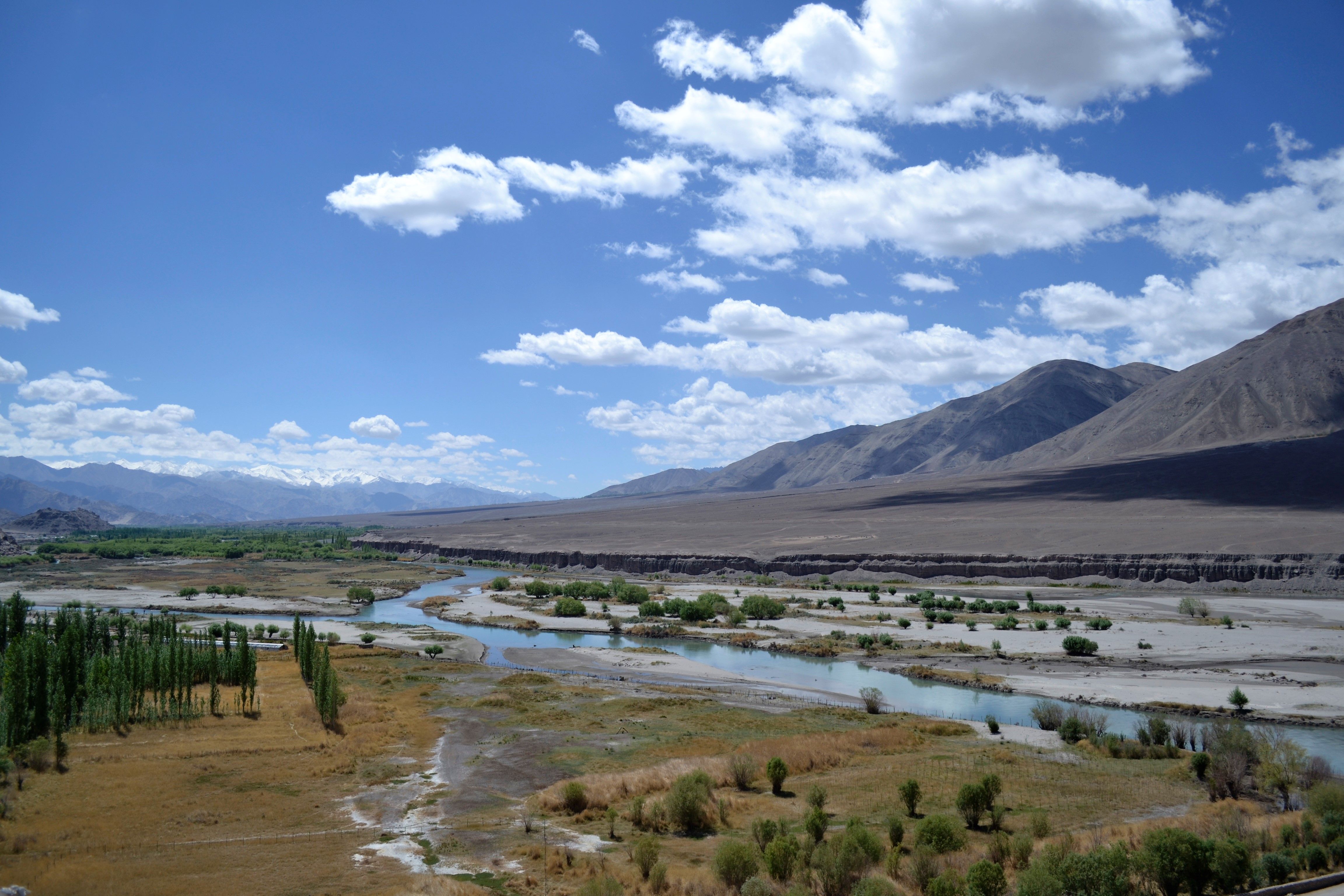 Clouds over River on Plains near Mountains · Free Stock Photo