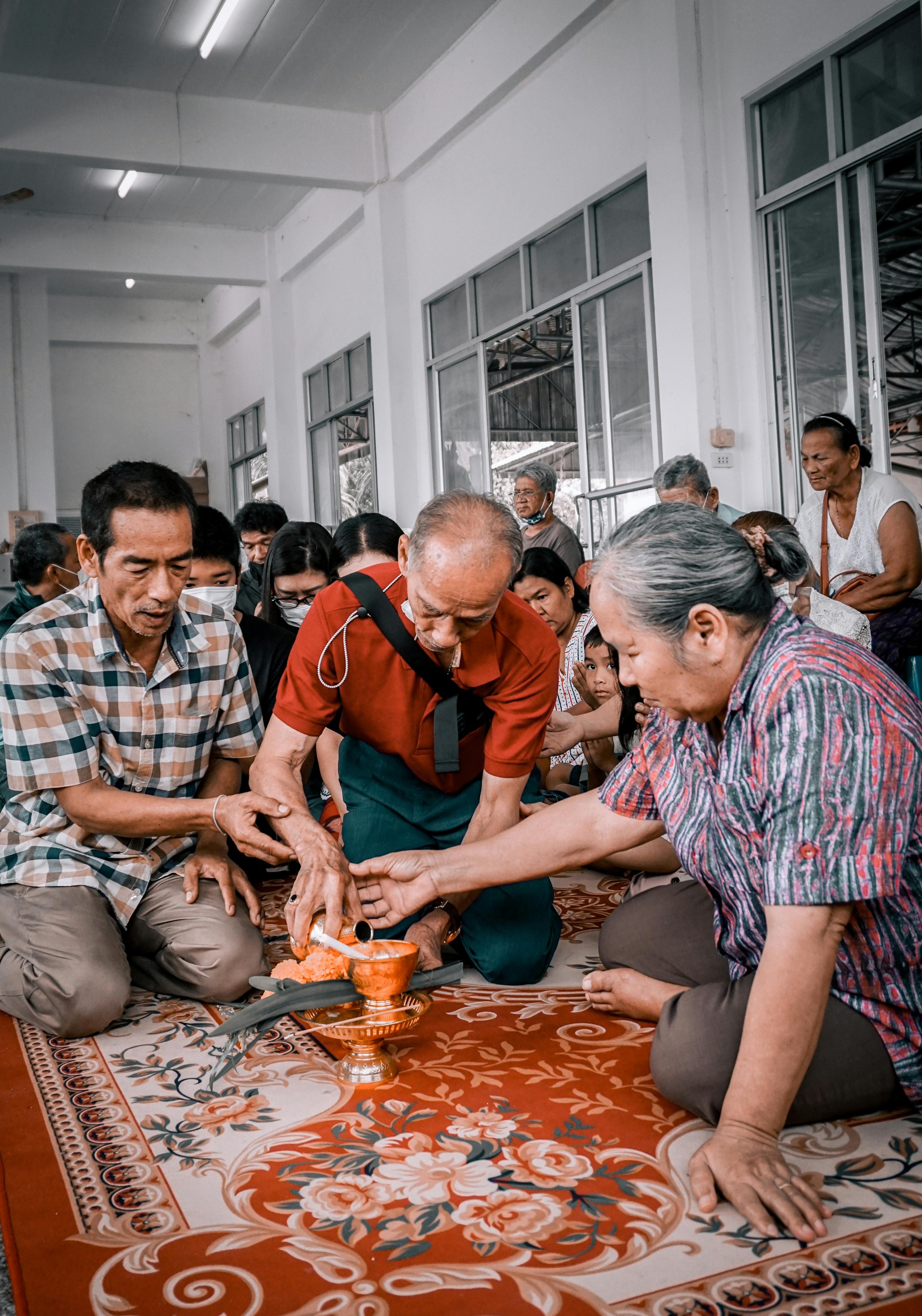 Elderly Men Cooperating on Carpet in Temple · Free Stock Photo