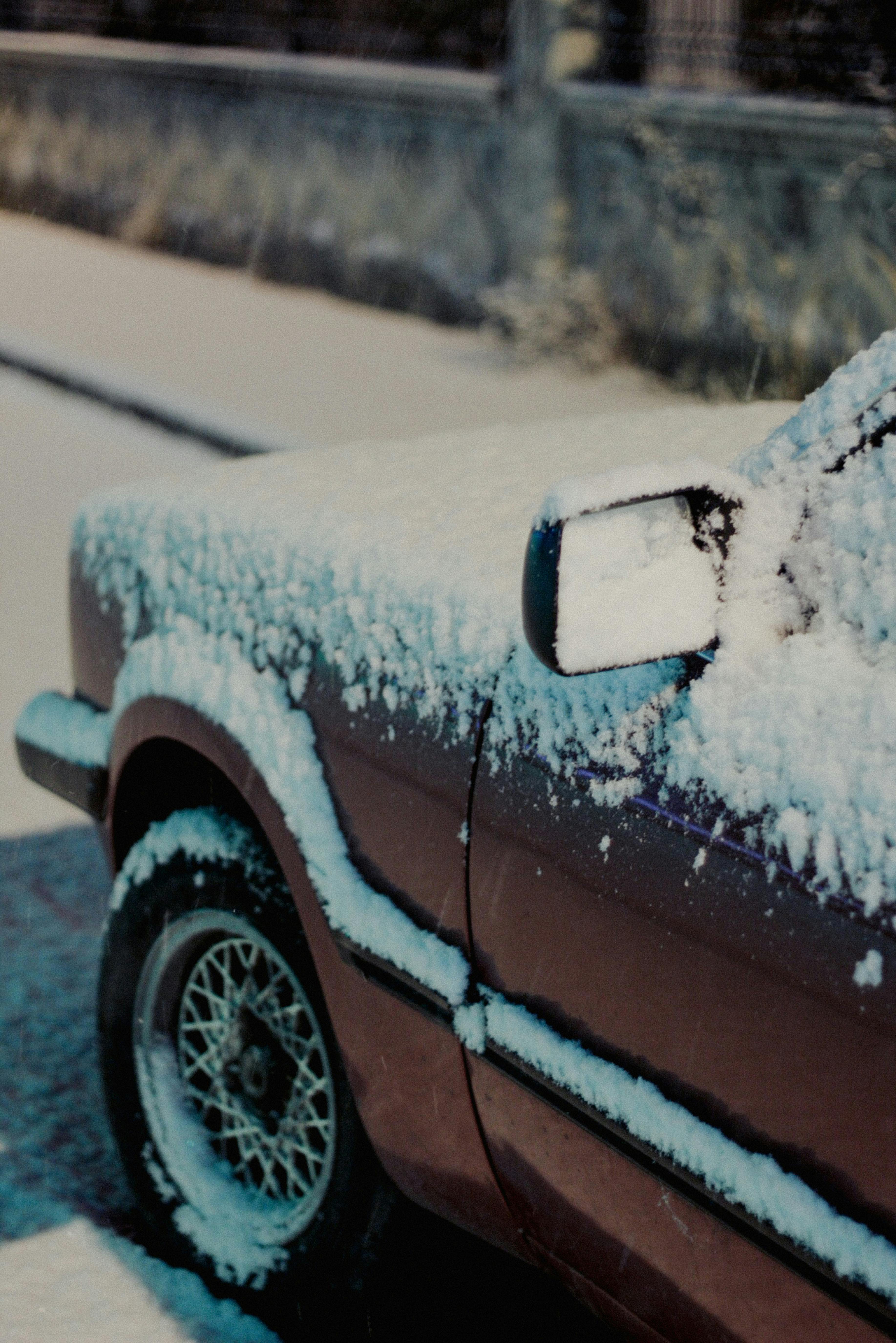 Man on a Snow Covered Forest Road in Front of His Car · Free Stock Photo