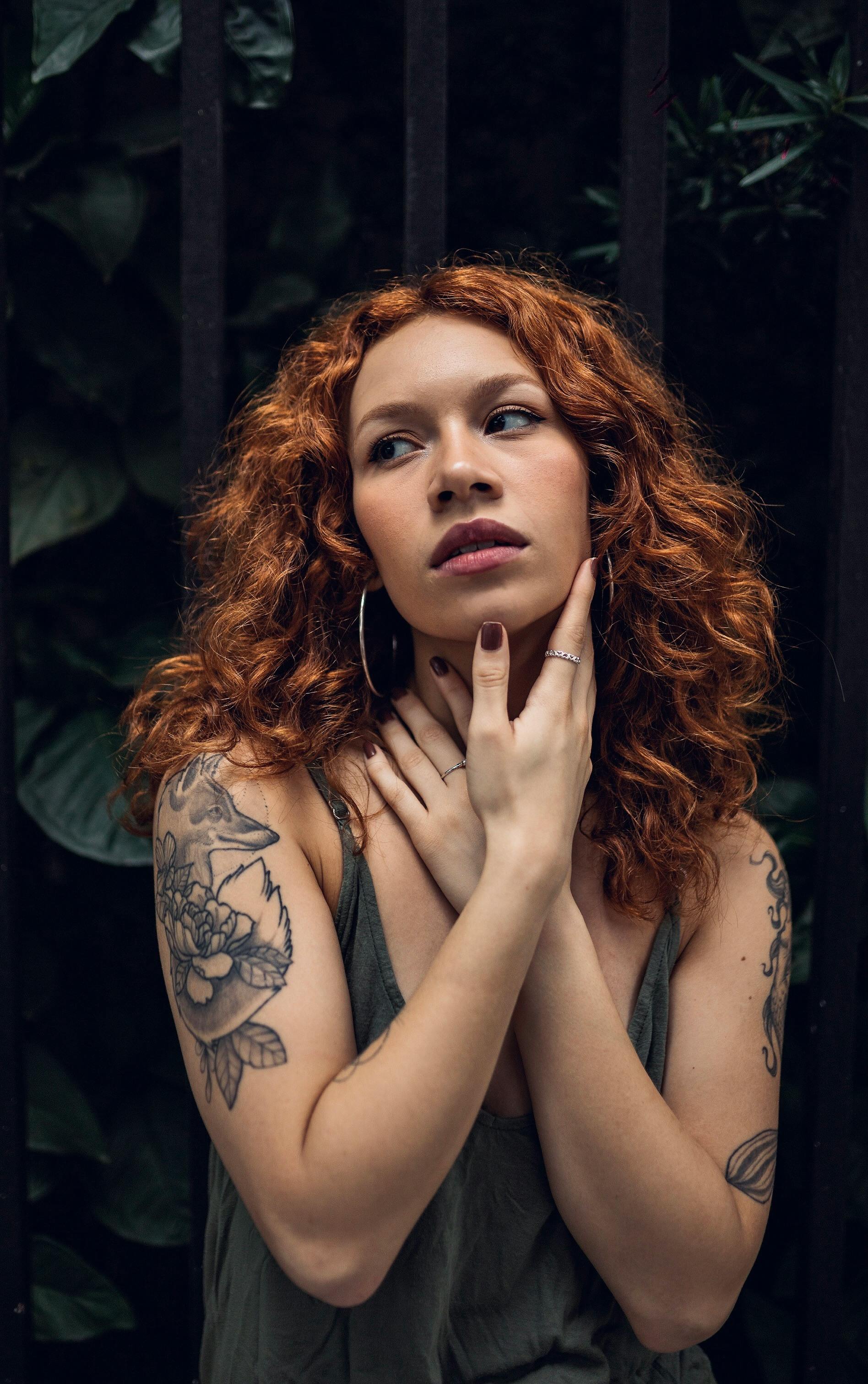 Redhead Woman with Tattoos Posing in Nature · Free Stock Photo