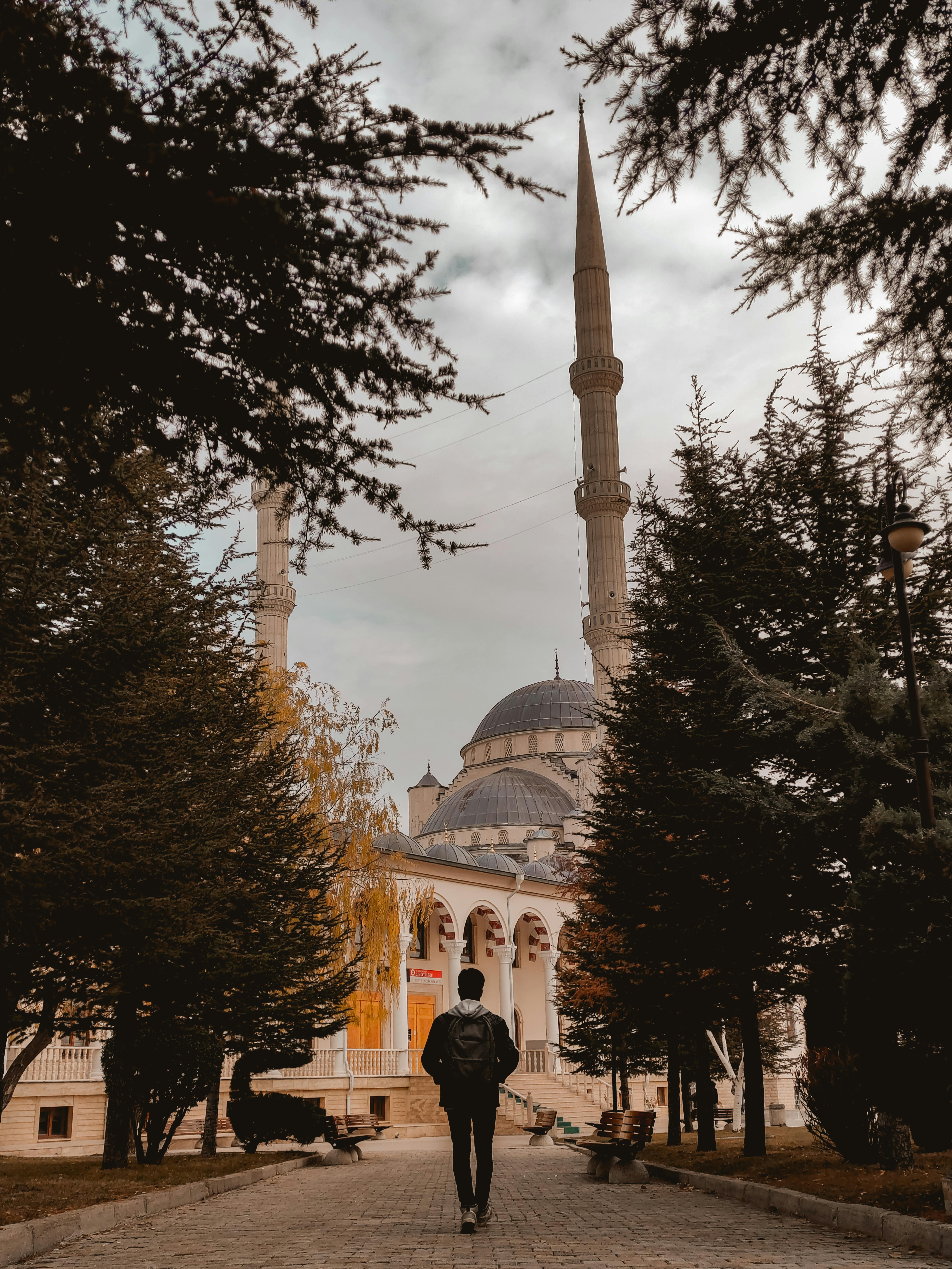 Man Walking towards Mosque · Free Stock Photo