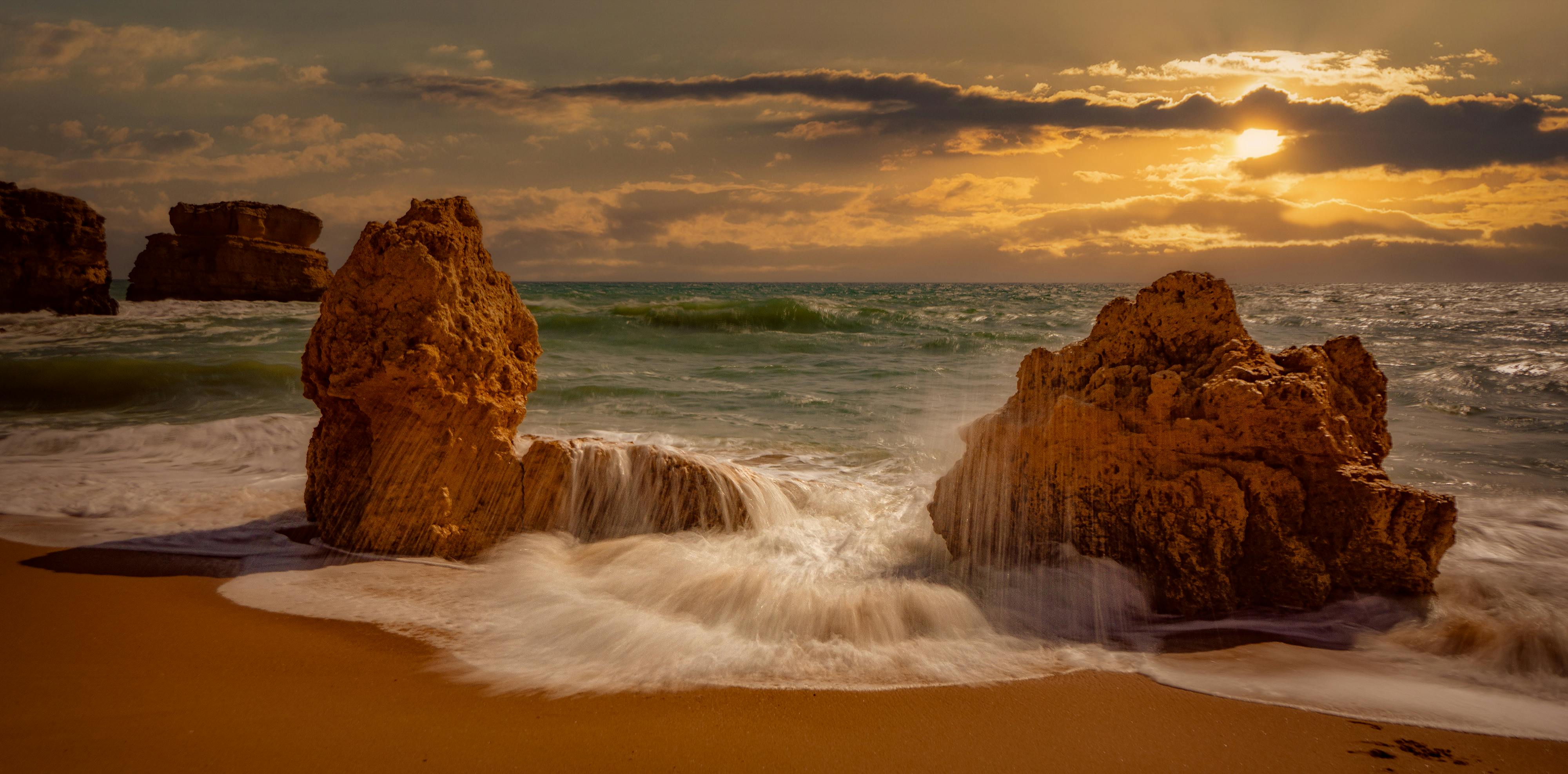 Water Spraying over the Rocks on a Beach · Free Stock Photo