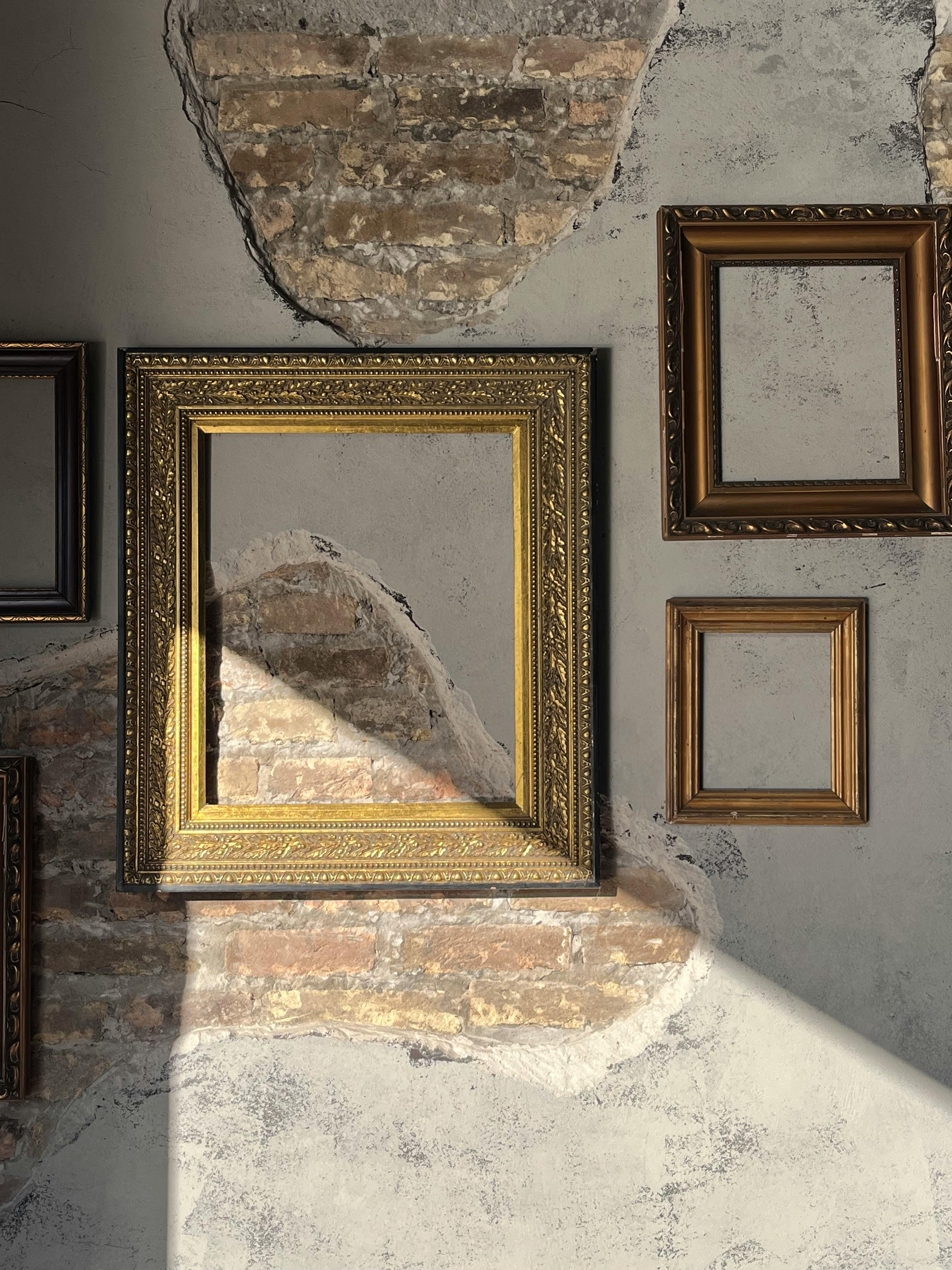 Frames Hanging on Damaged Wall · Free Stock Photo