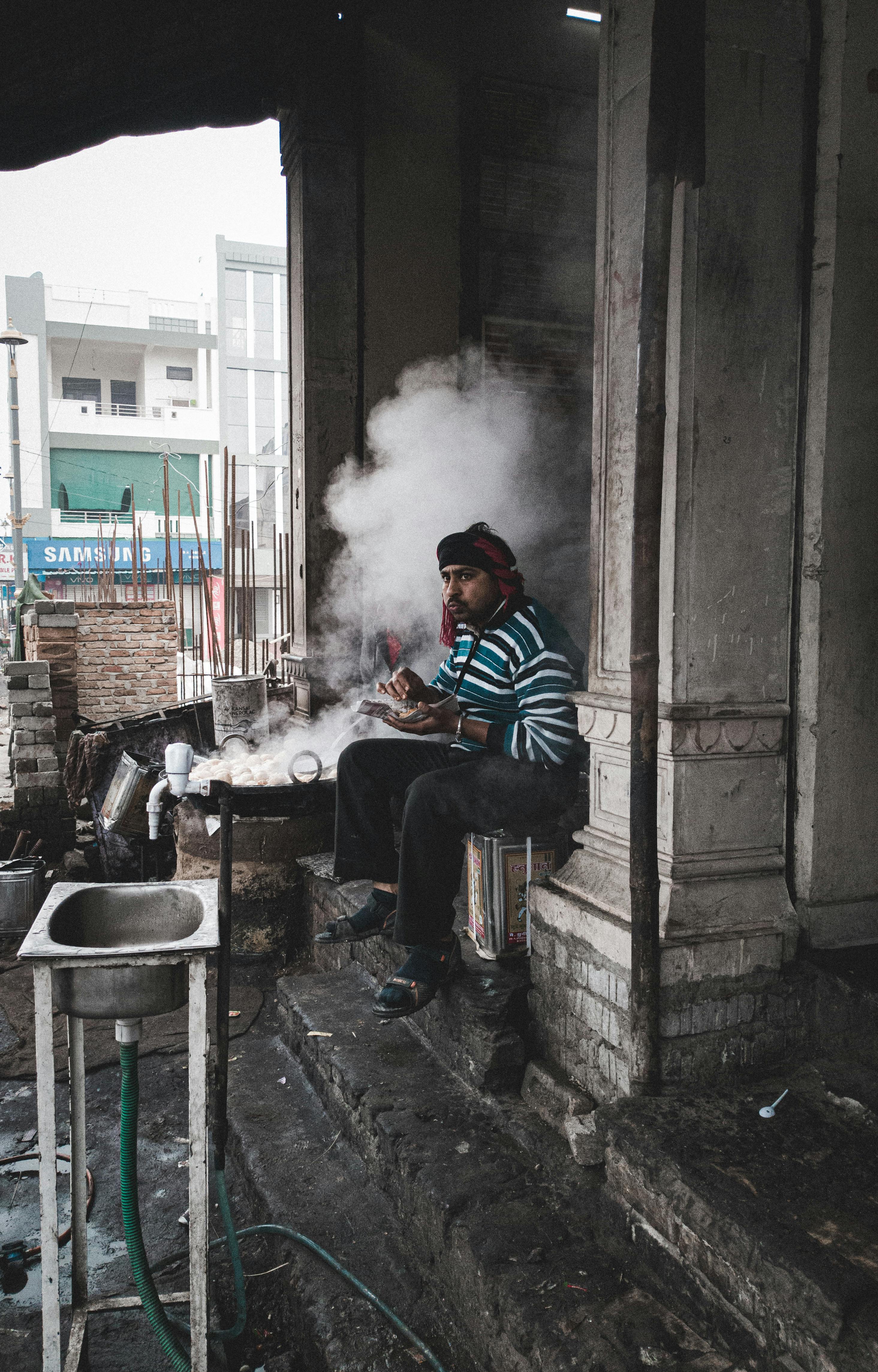 Sitting Man Eating on Street · Free Stock Photo