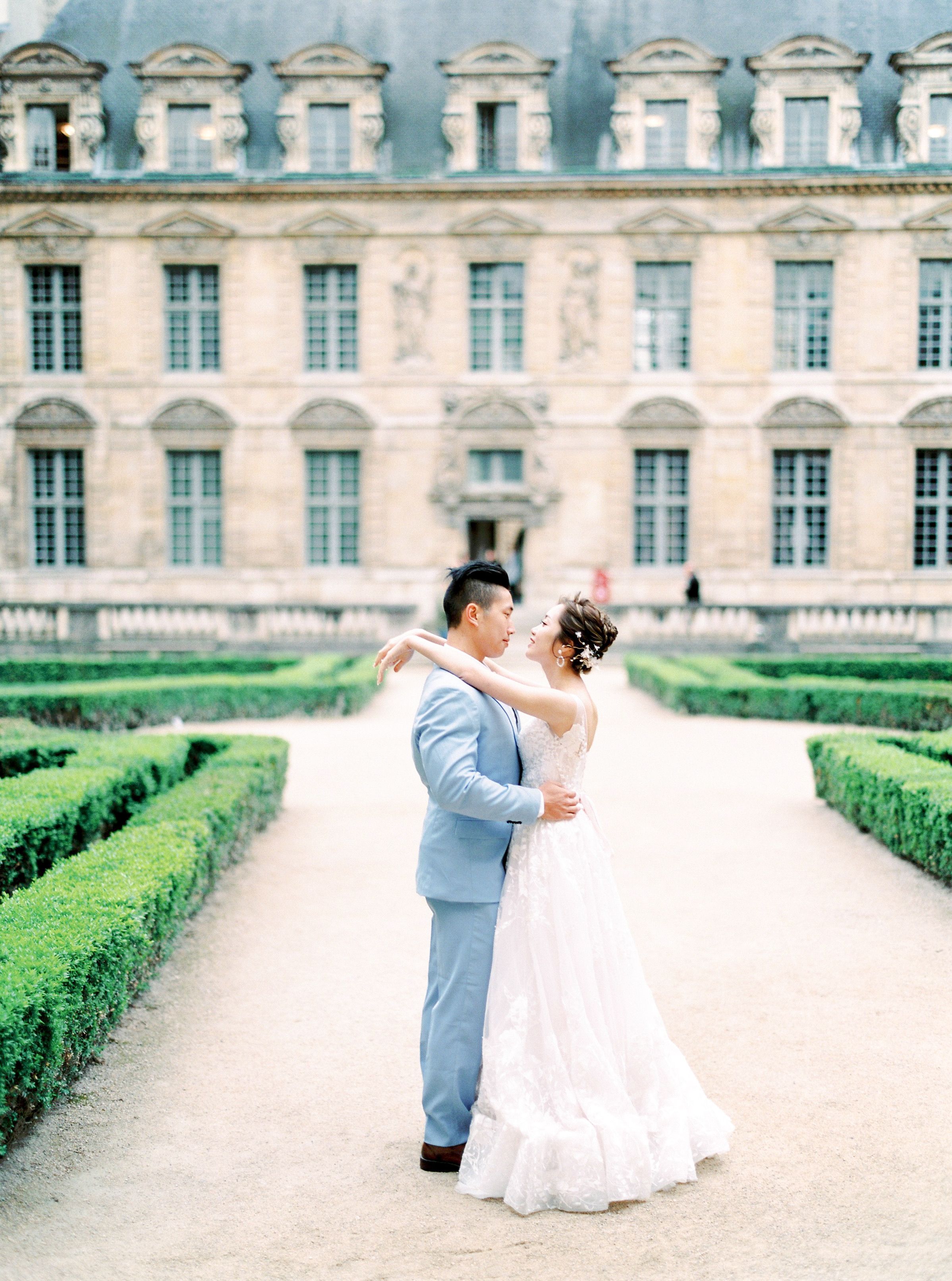 Newlywed Couple Standing in front of a Palace · Free Stock Photo