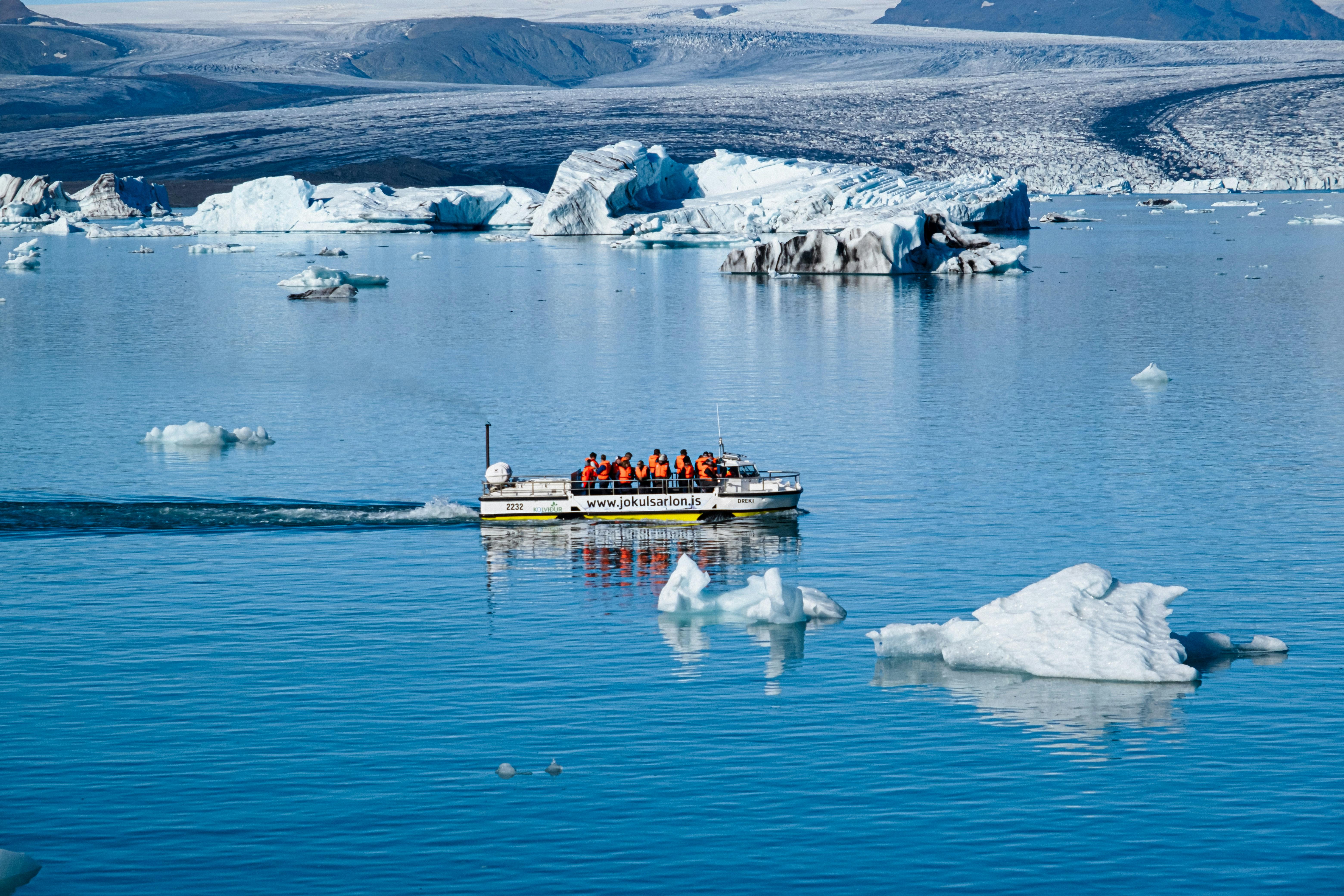 People on Boat in Expedition in Water with Glaciers · Free Stock Photo