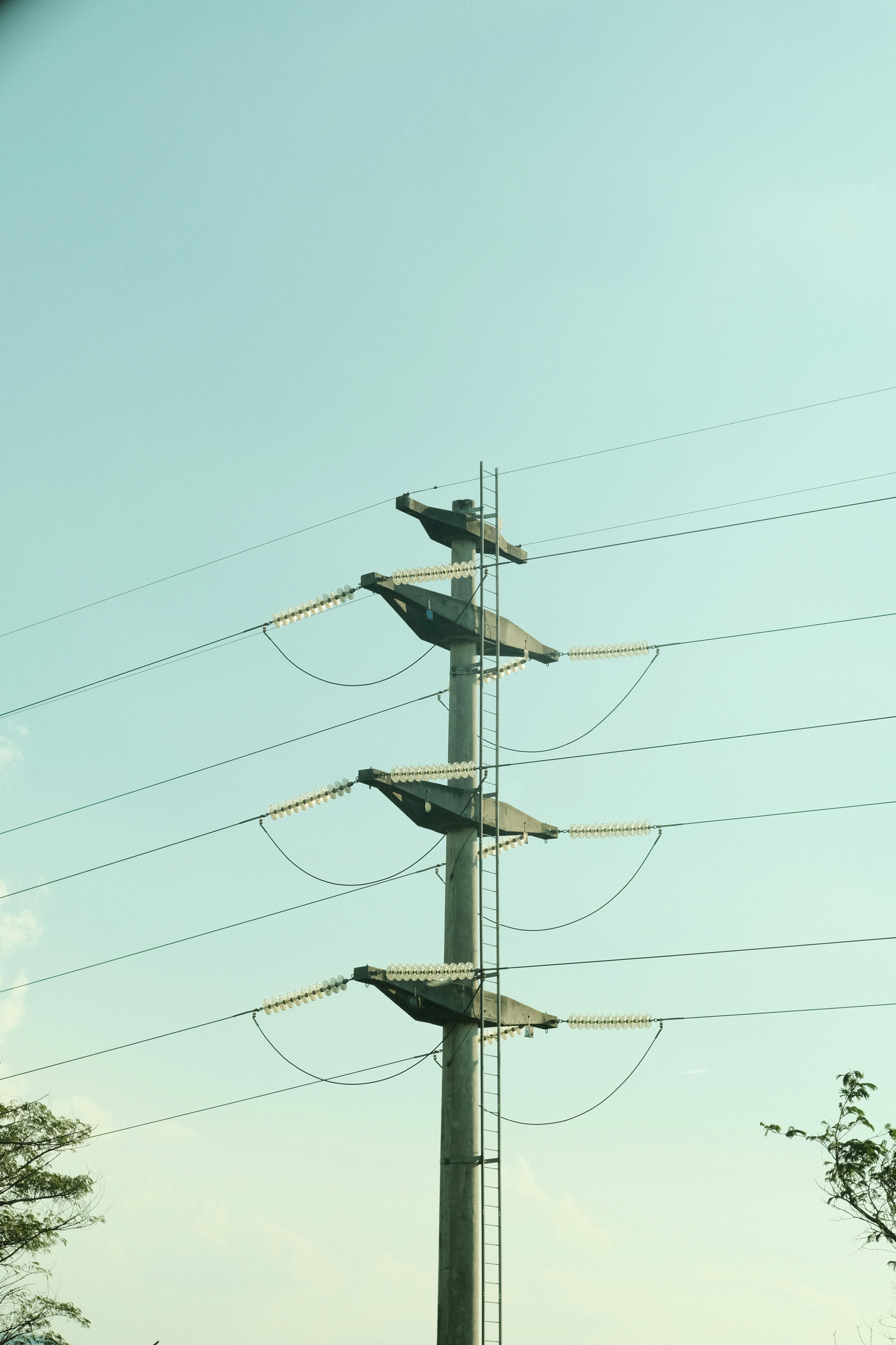 A Gray Electric Post Under Cloudy Sky · Free Stock Photo