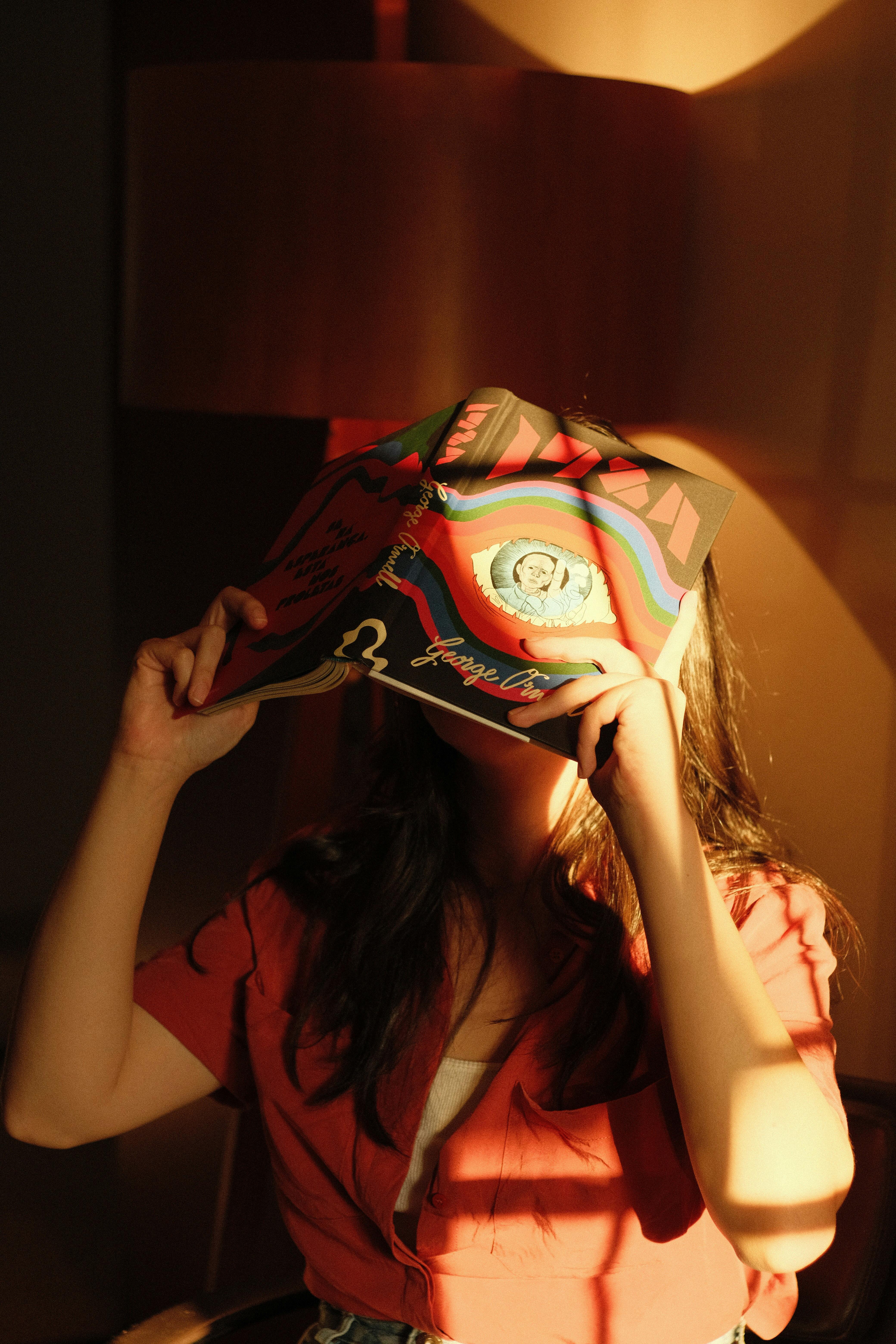 Woman Covering His Face with a Book · Free Stock Photo