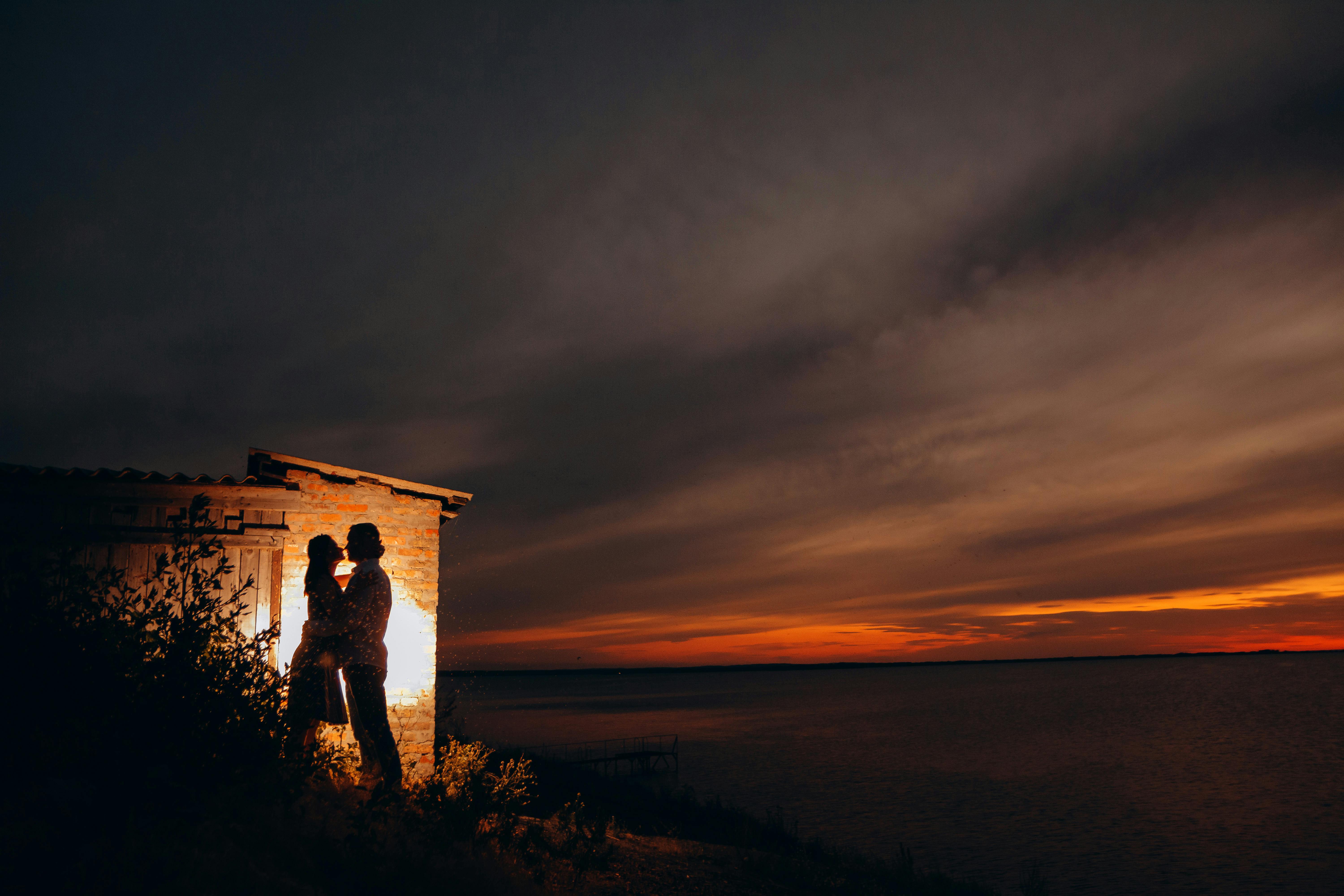 Silhouette of Couple Hugging at Sunset · Free Stock Photo