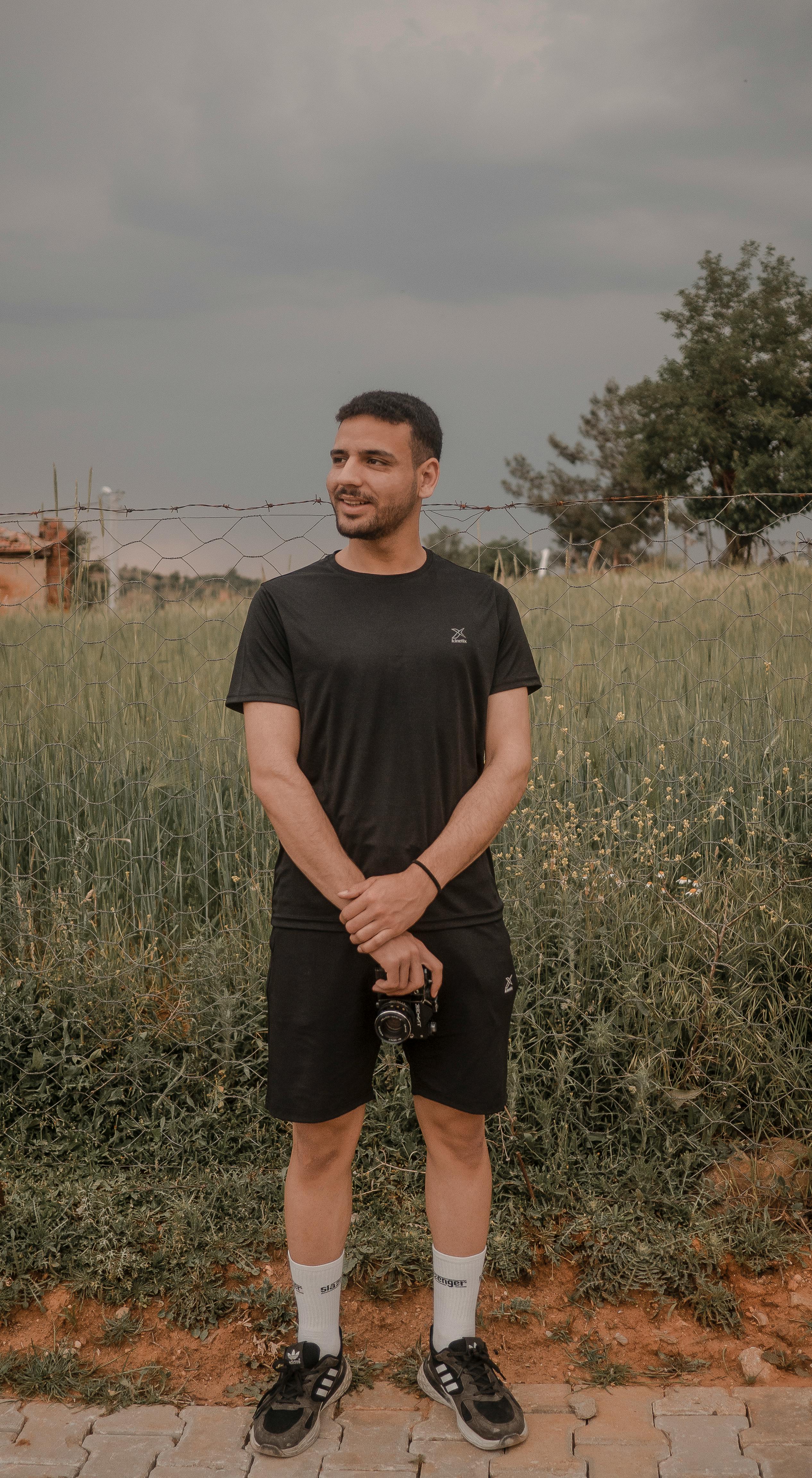 Portrait of a Man Standing in a Field · Free Stock Photo