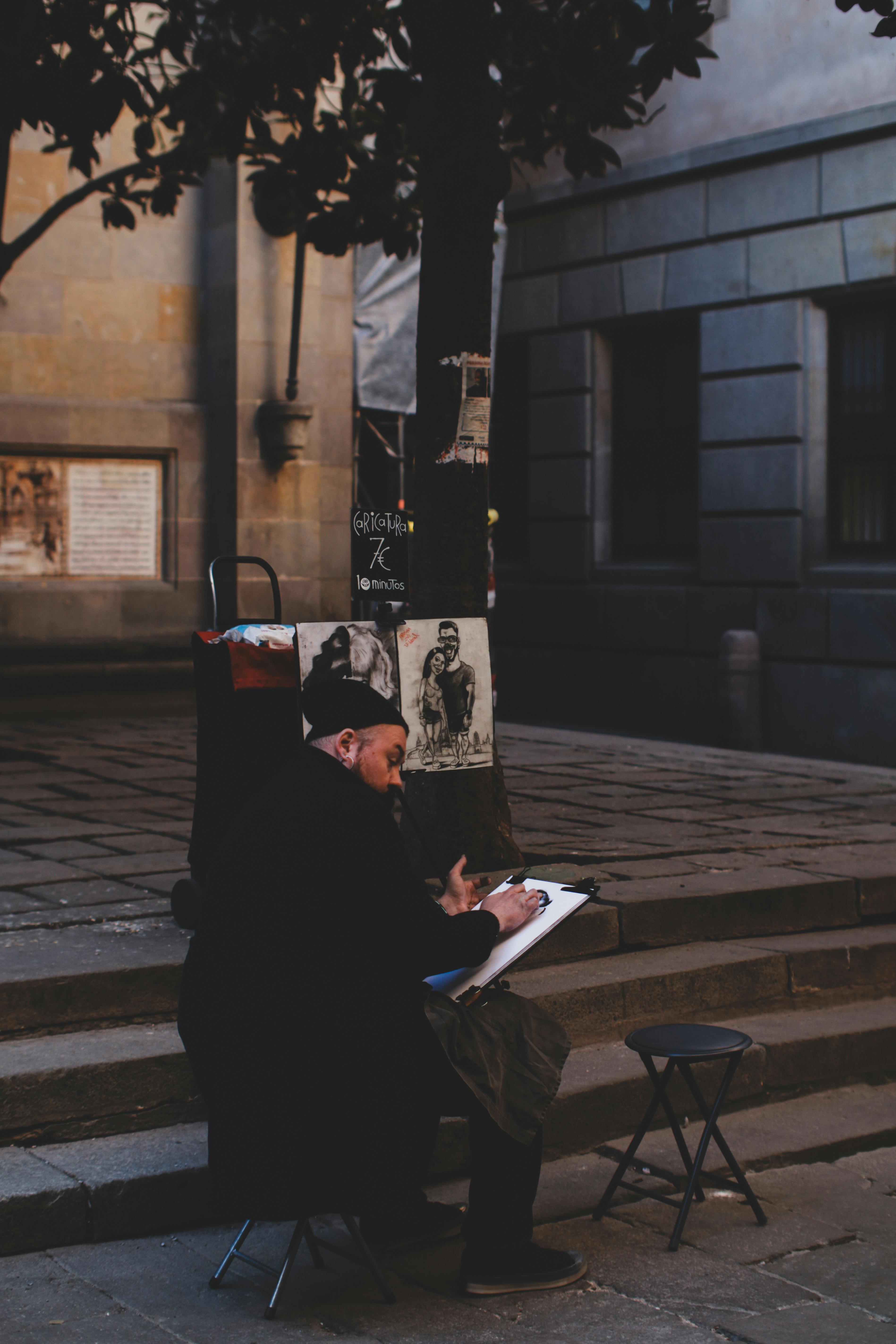 A Street Artist Drawing a Portrait · Free Stock Photo