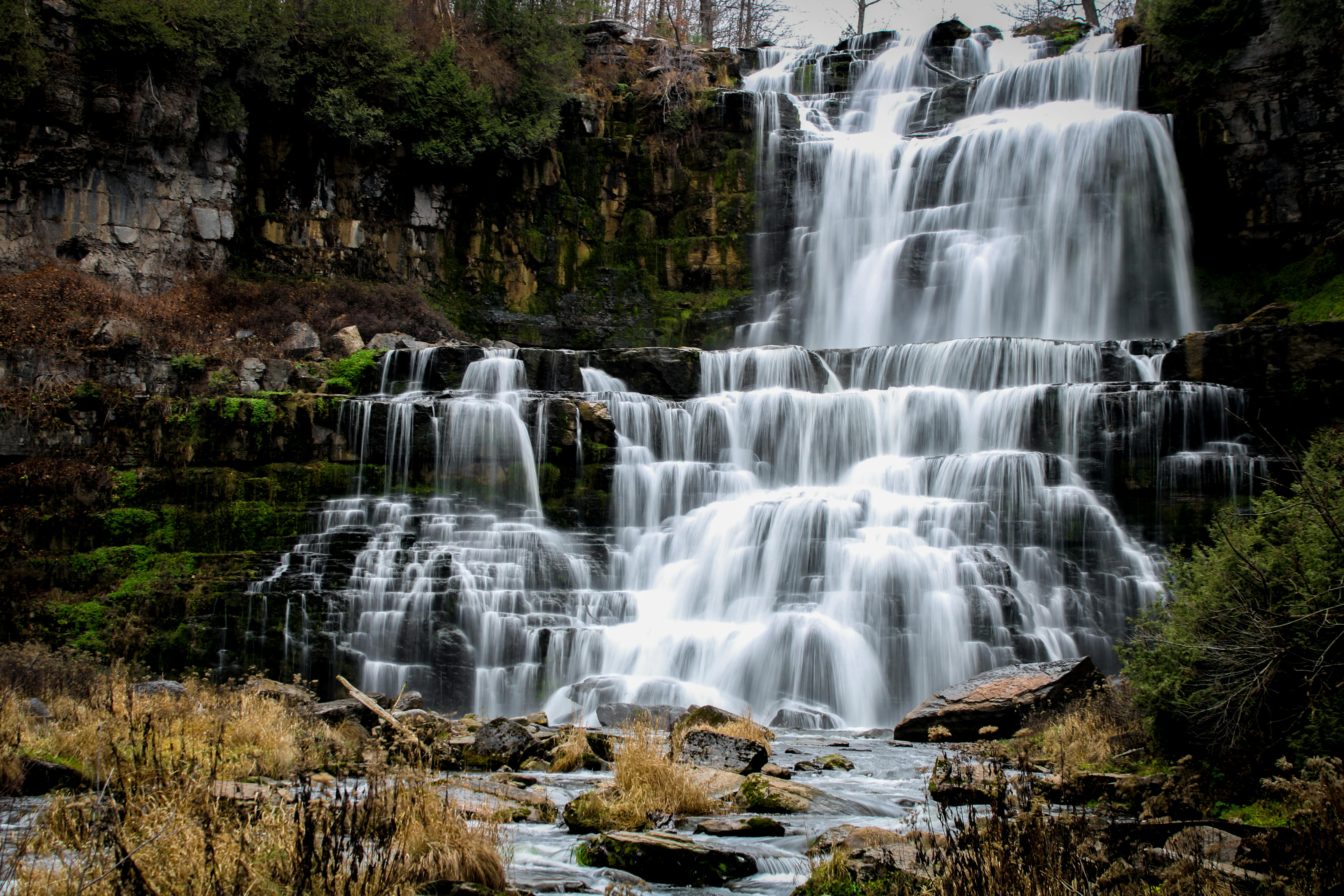 Waterfall on Cliff With Trees during Fall · Free Stock Photo