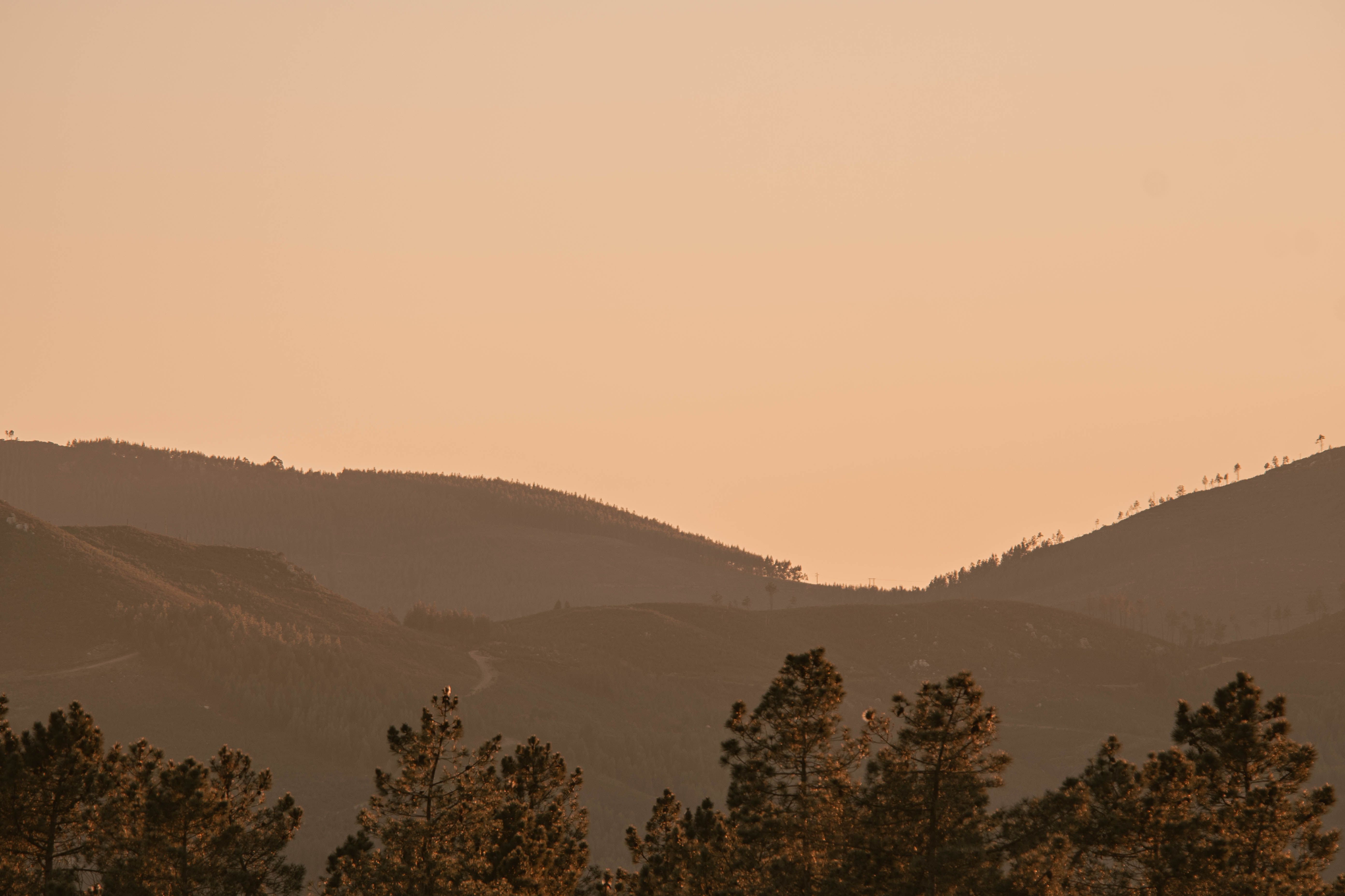 Yellow Sky over Hills · Free Stock Photo