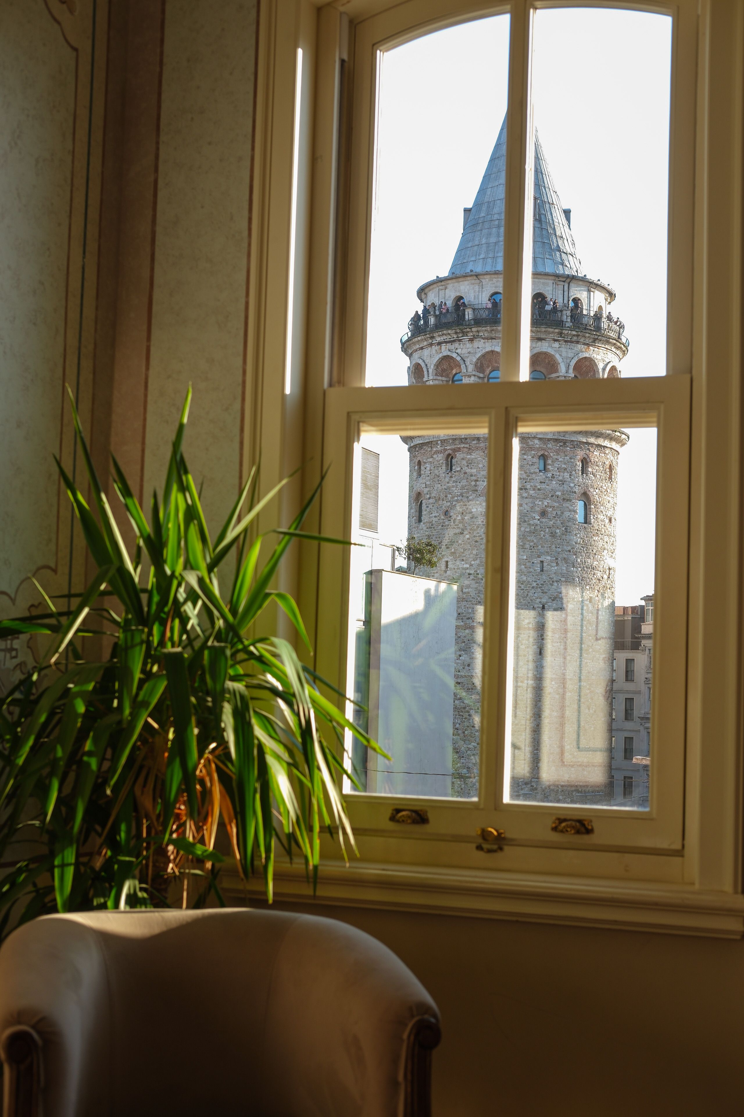 A view of a window with a tower in the background · Free Stock Photo