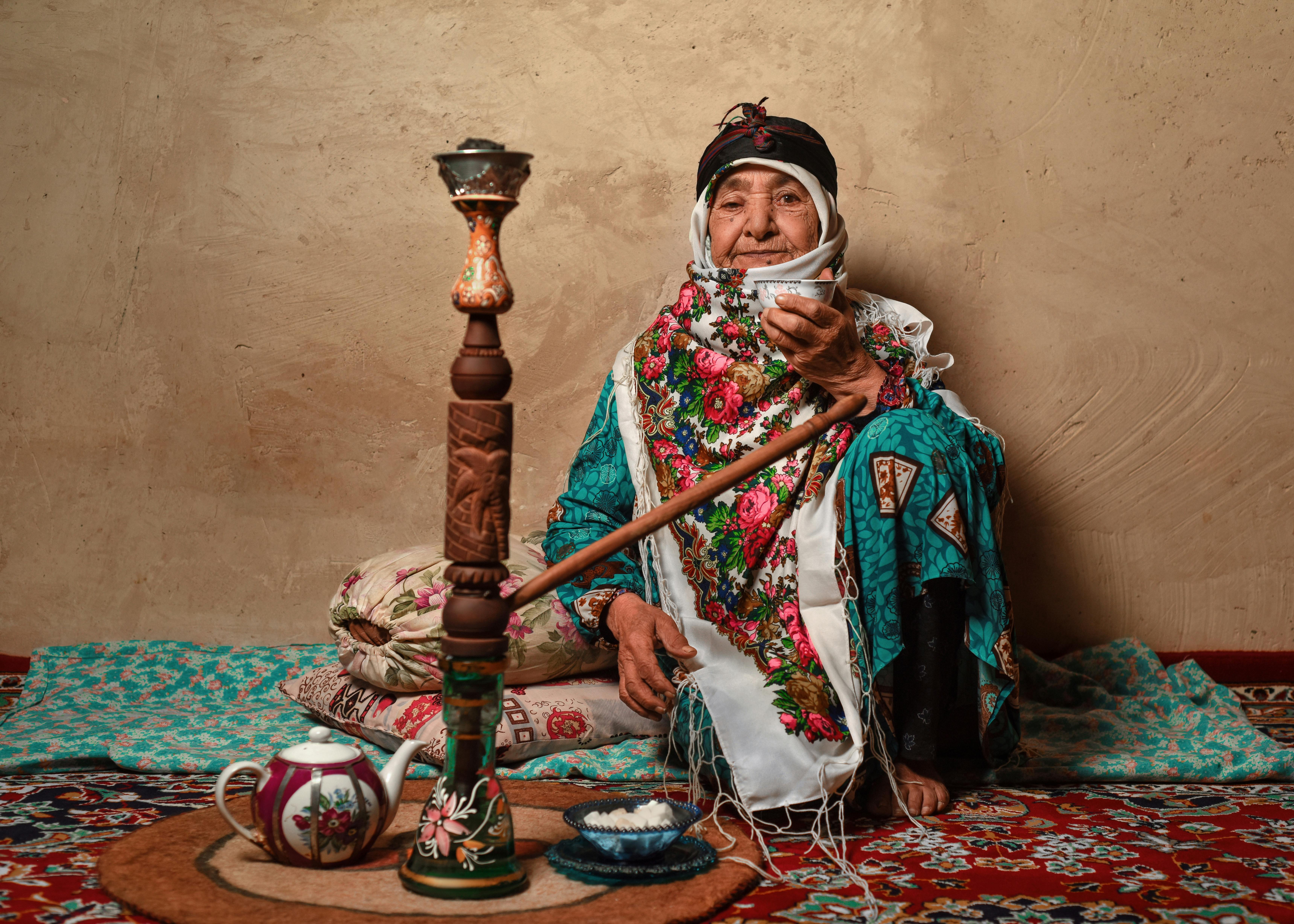 Elderly Iranian Woman with Hookah in Home · Free Stock Photo