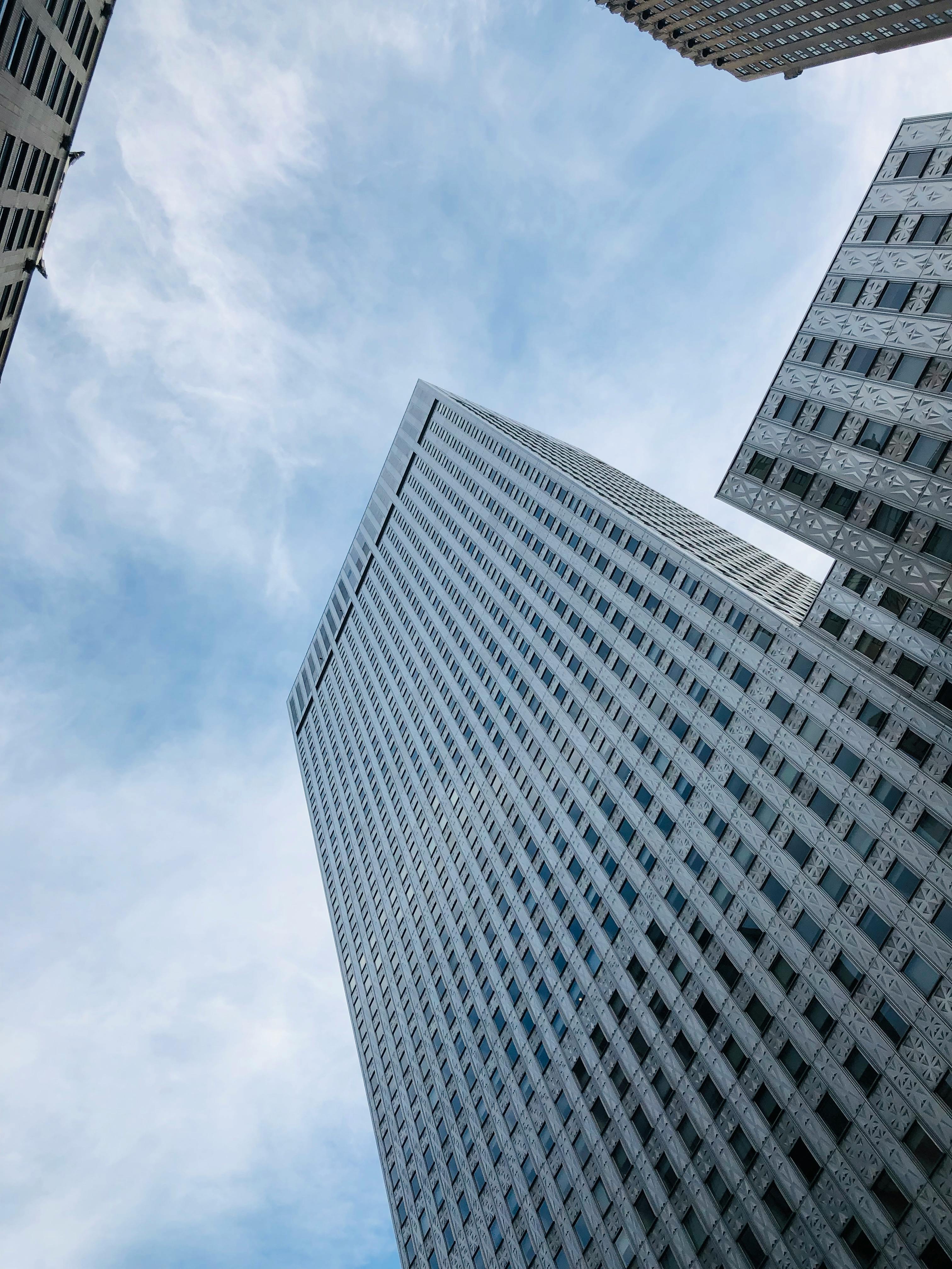 Low Angle Photography of Glass Building Under White Cloud and Blue Sky ...