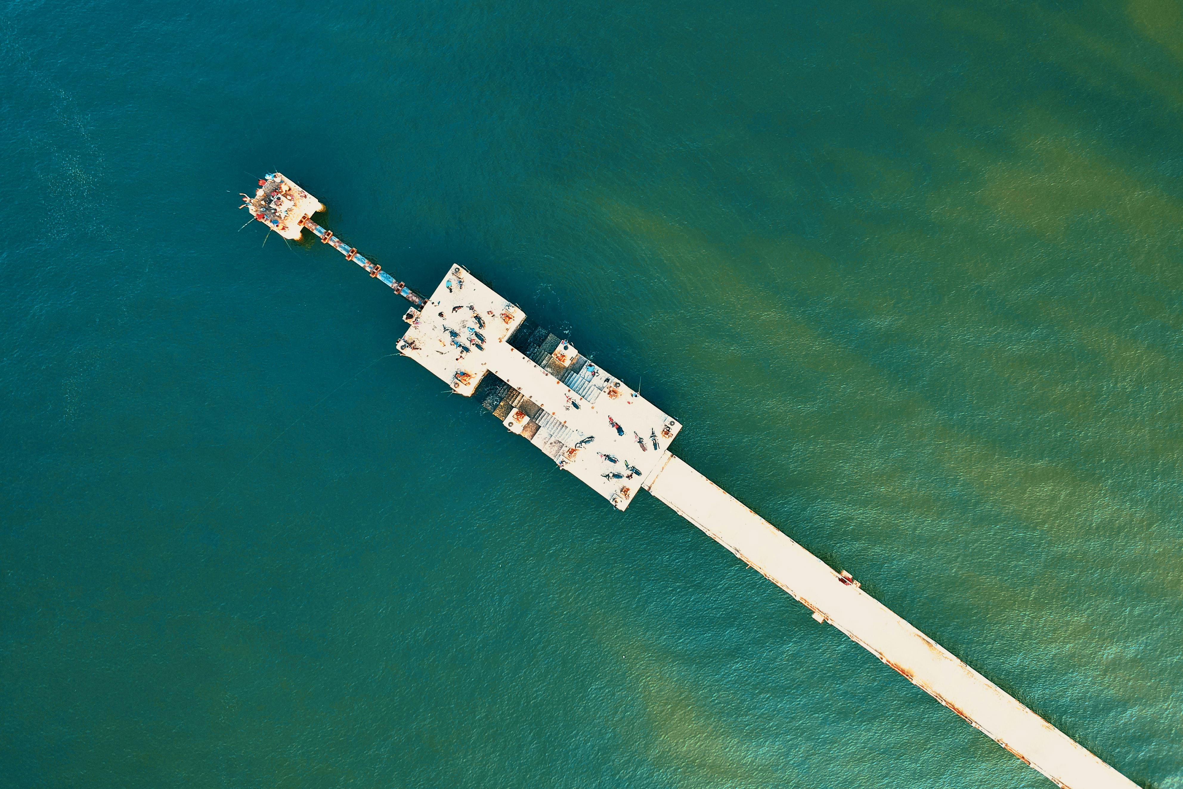 High Angle-photography of White Sea Dock on Green Water · Free Stock Photo