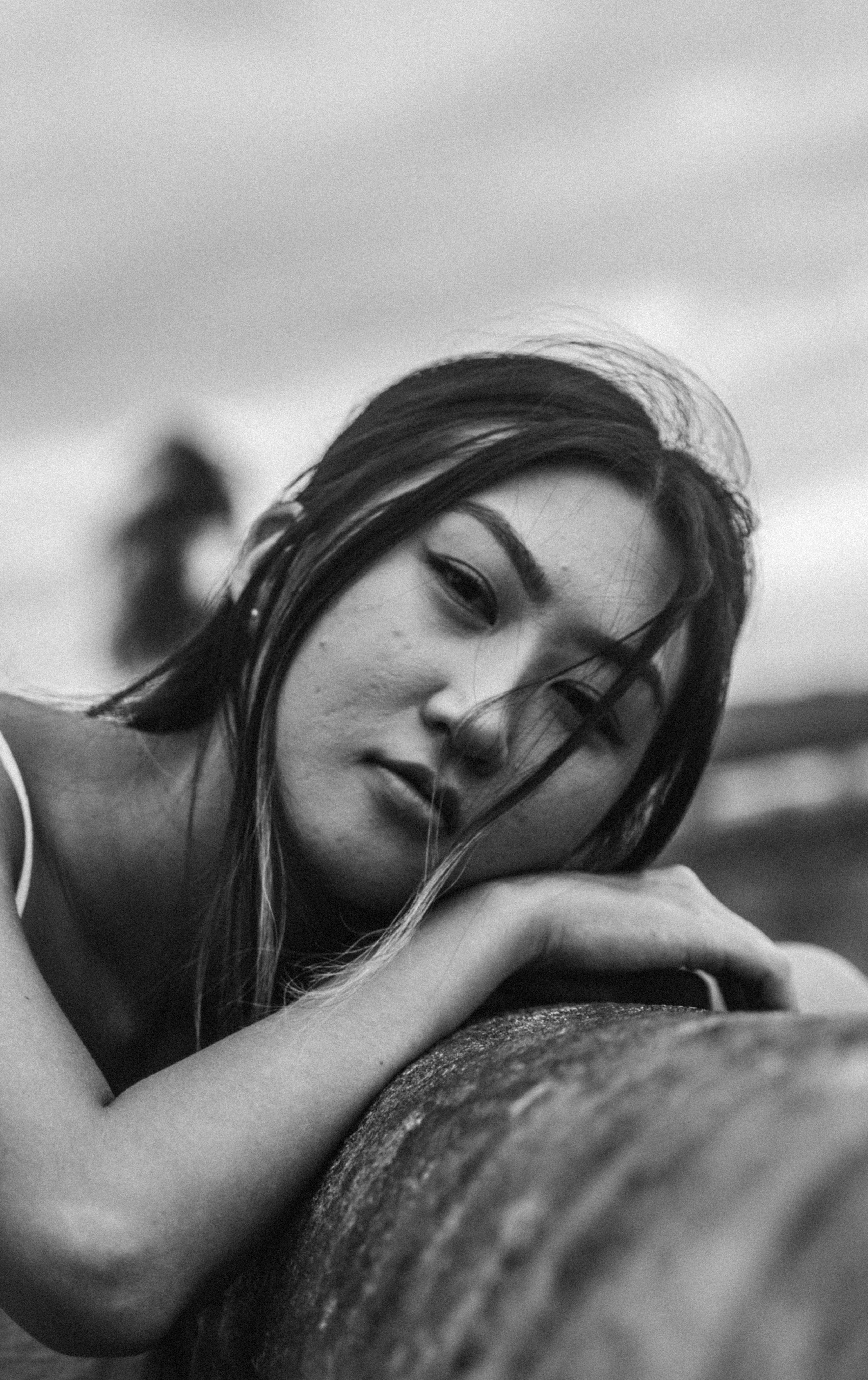 Young Asian Woman Leaning Her Head on a Wooden Log · Free Stock Photo
