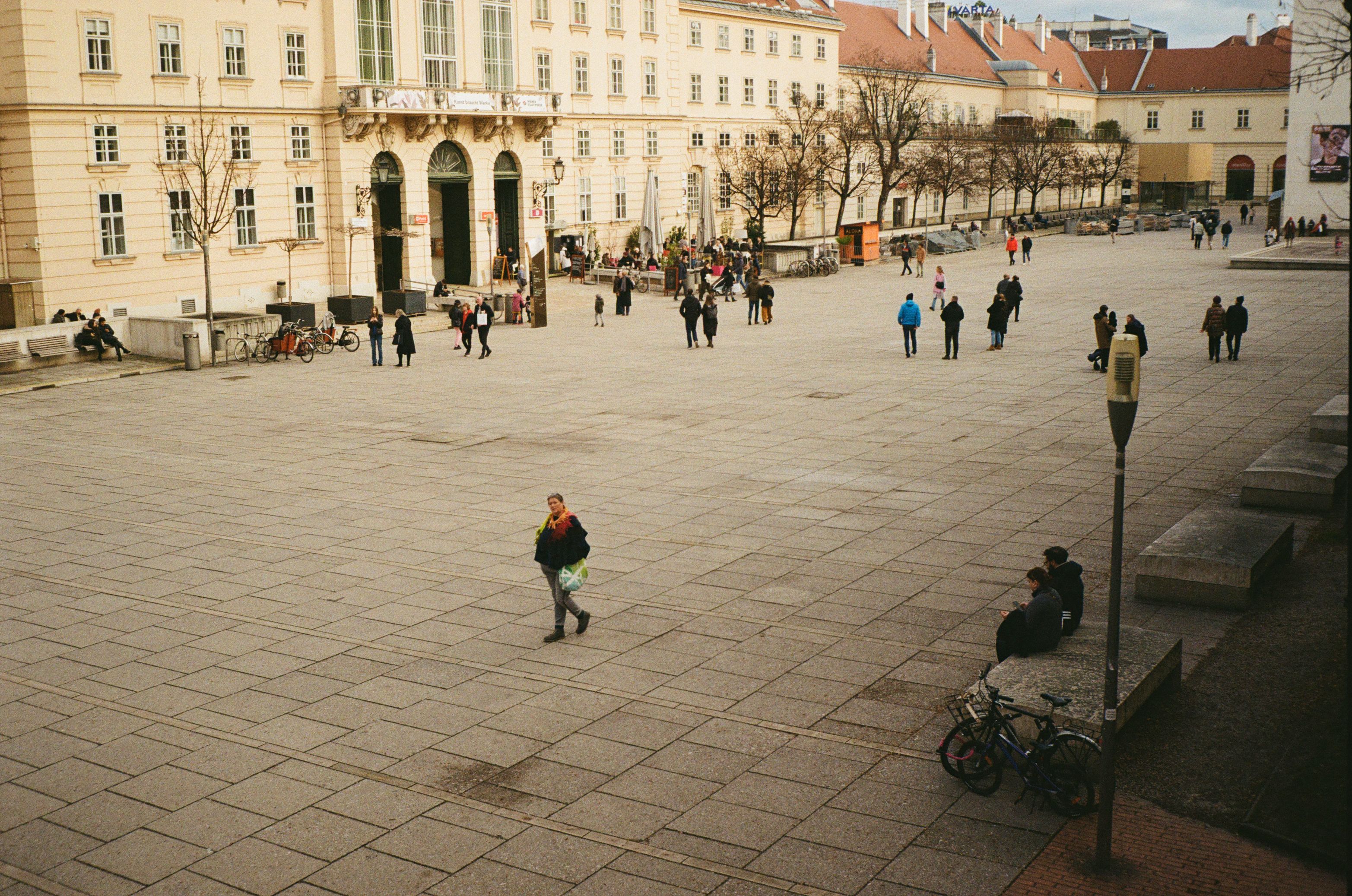 Woman Walking across Town Square at Sunset · Free Stock Photo
