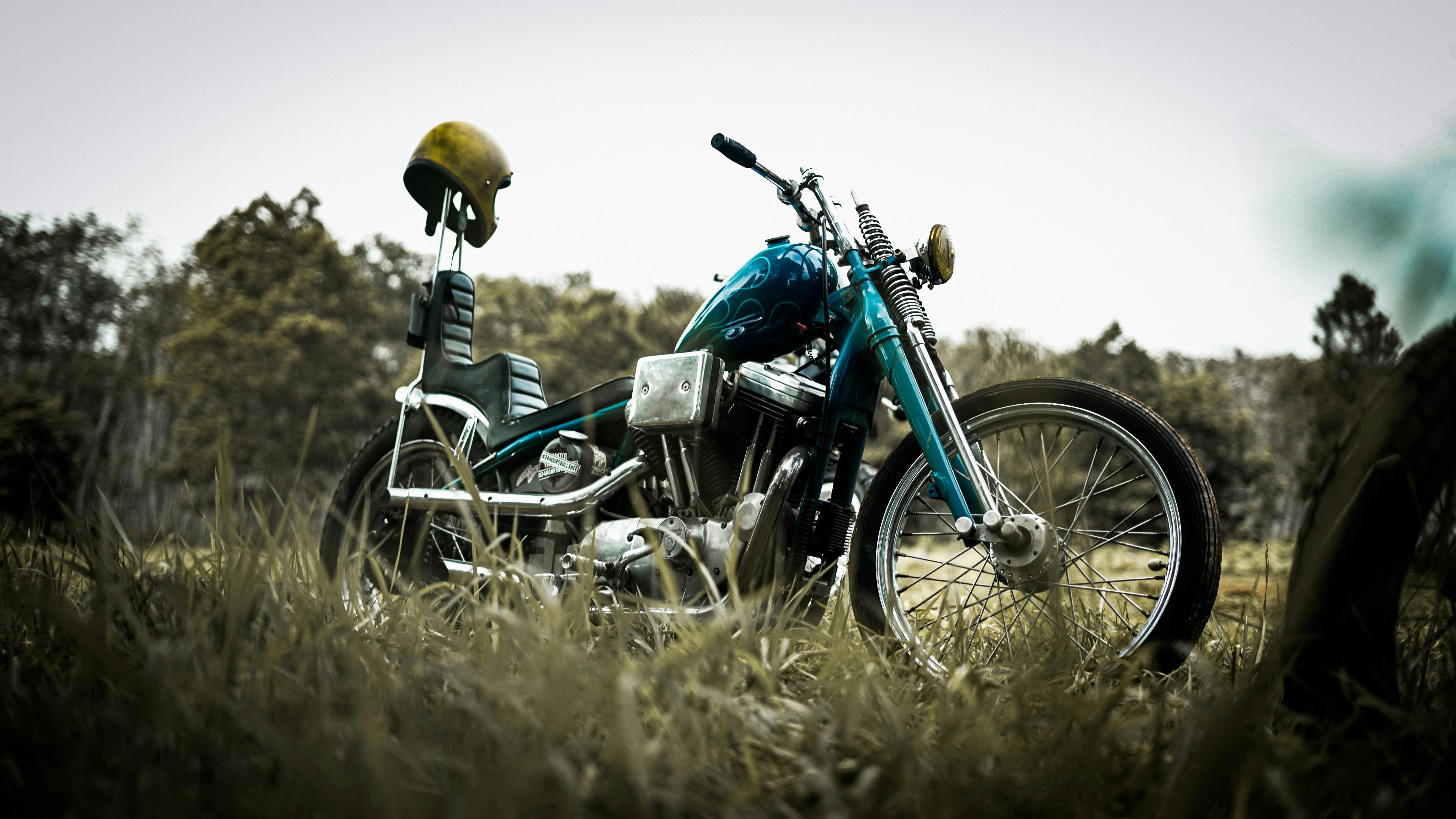 A Motorcycle Parked on a Grass Field · Free Stock Photo