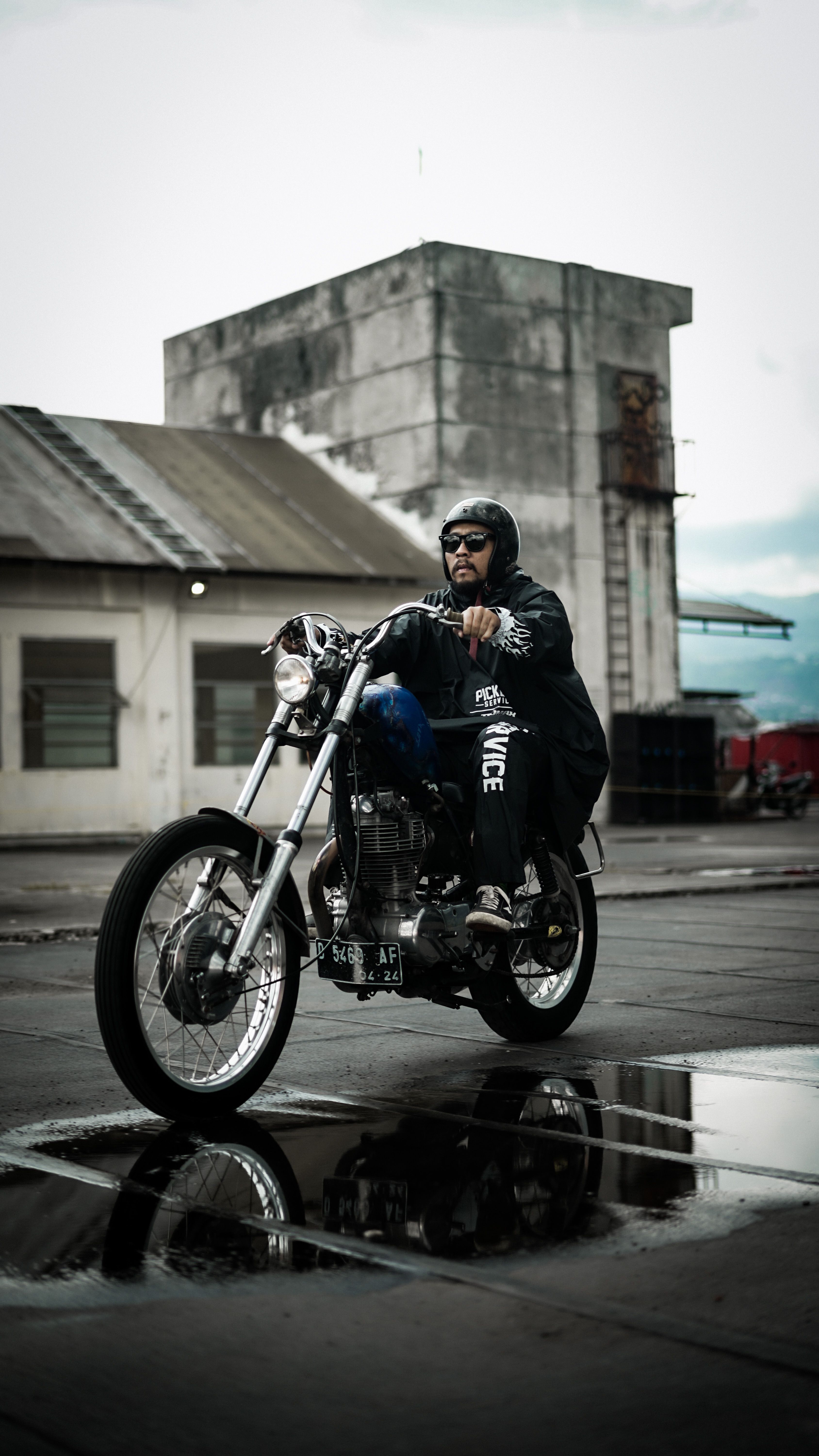 Photo of a Man Sitting on a Motorcycle Reflecting in a Puddle · Free ...