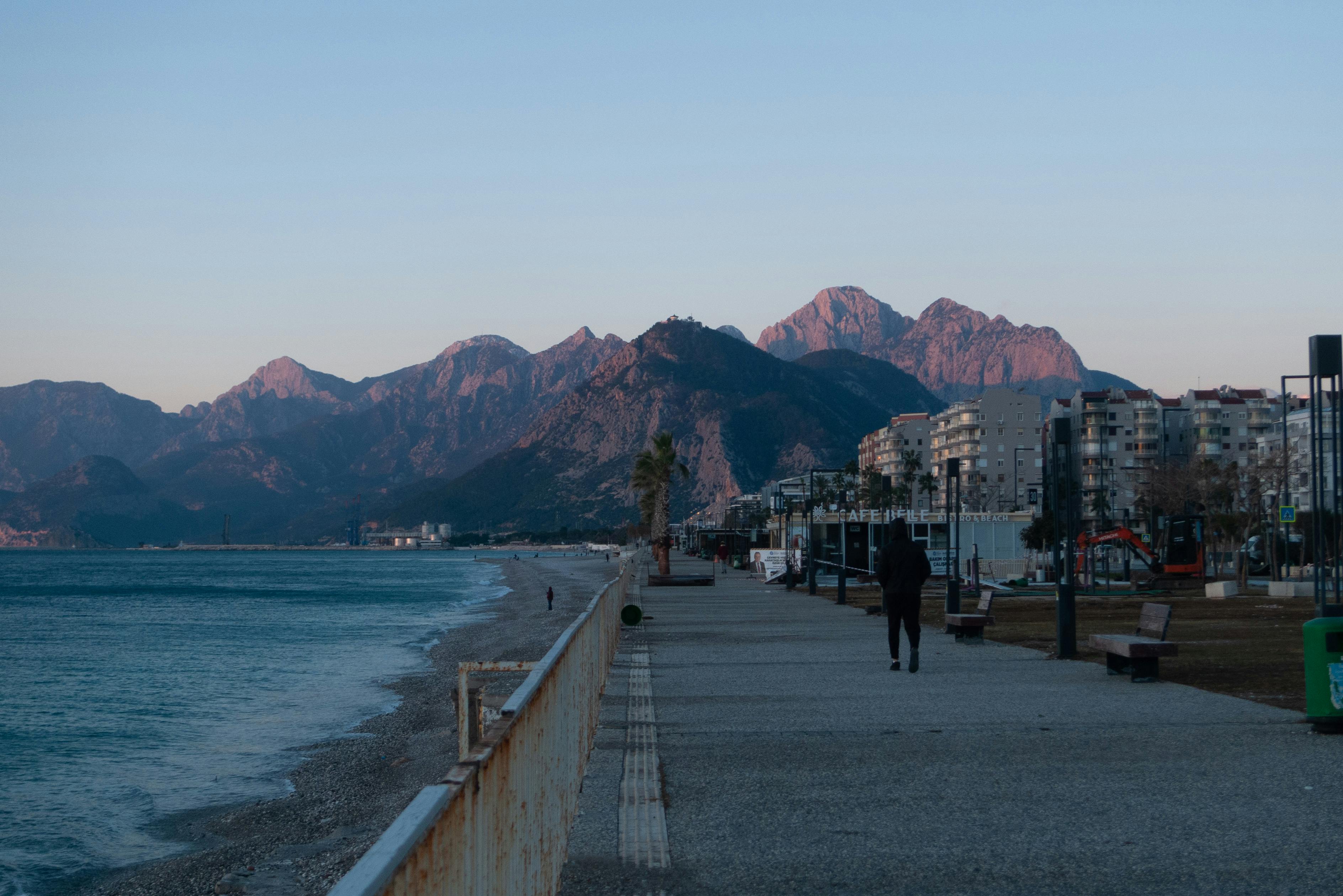 A Pavement by the Beach in a Coastal Town with the View of Mountains ...