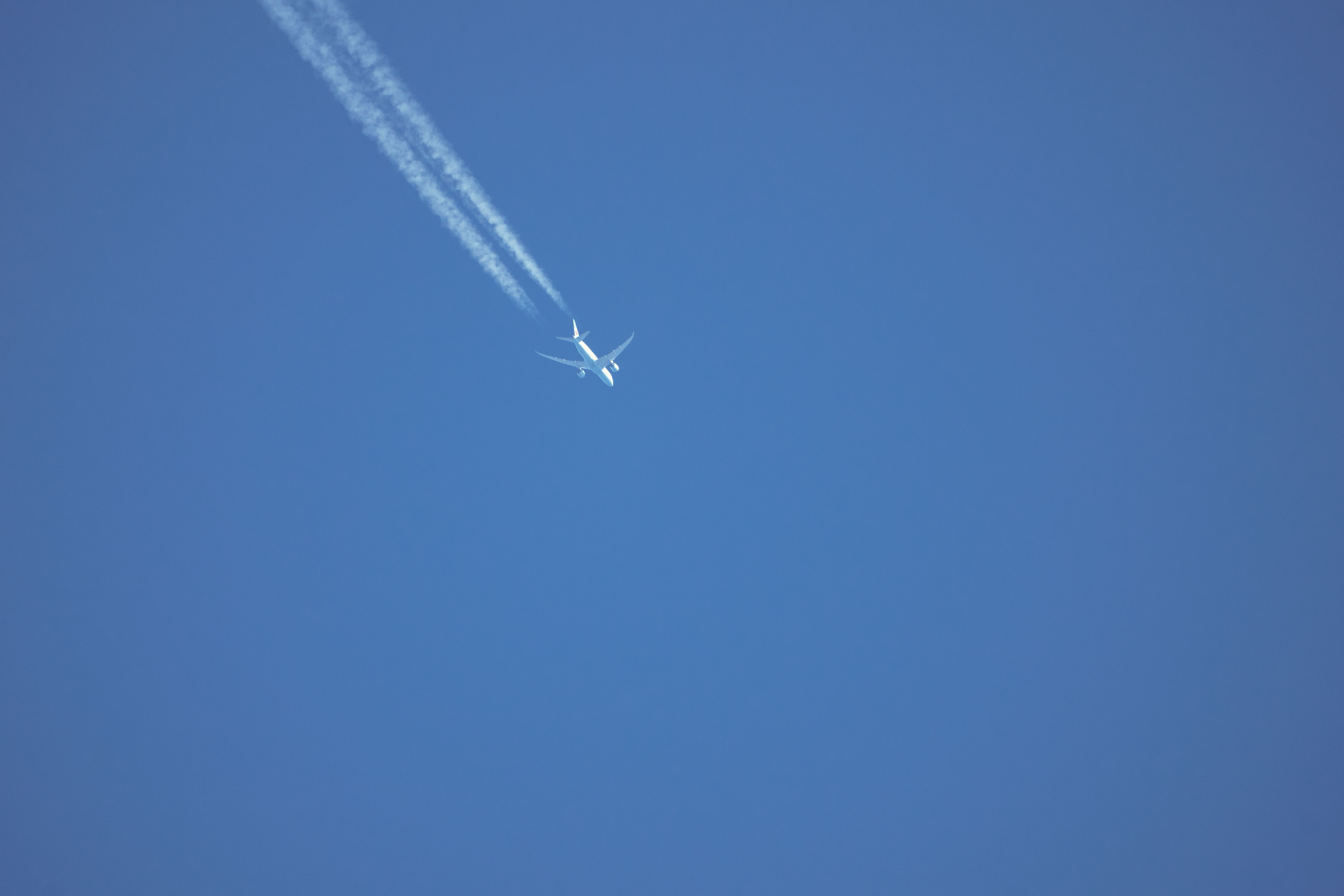 Low Angle Shot of an Airplane Flying in the Clear Blue Sky · Free Stock ...